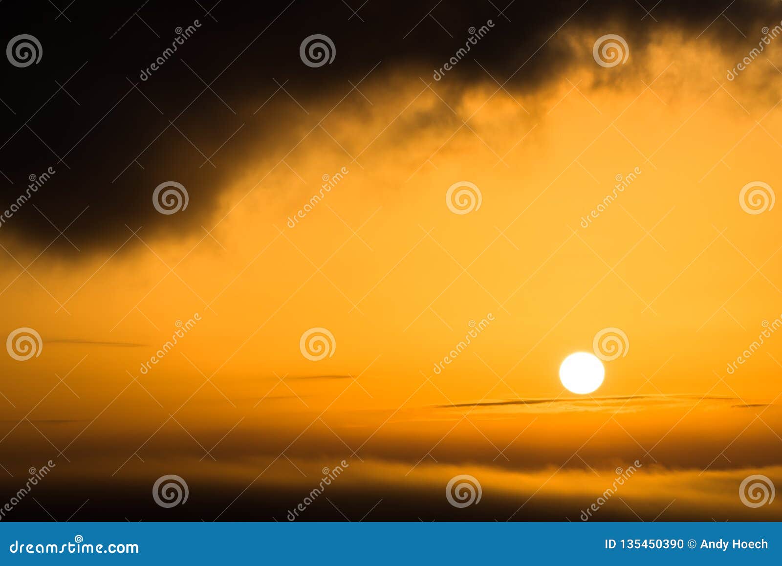 The Sun Shines As a Fireball between Two Cloud Layers Stock Photo ...