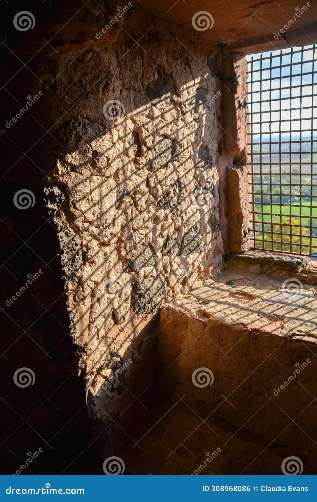 Sun Shines through an Old Castle Window with Bars with Shadows on the ...