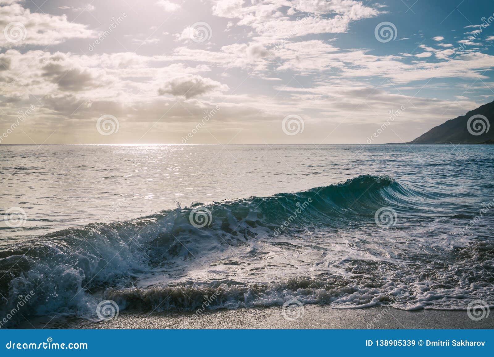 Sun Shining through the Clouds at Sandy Beach with Waves Stock Image ...