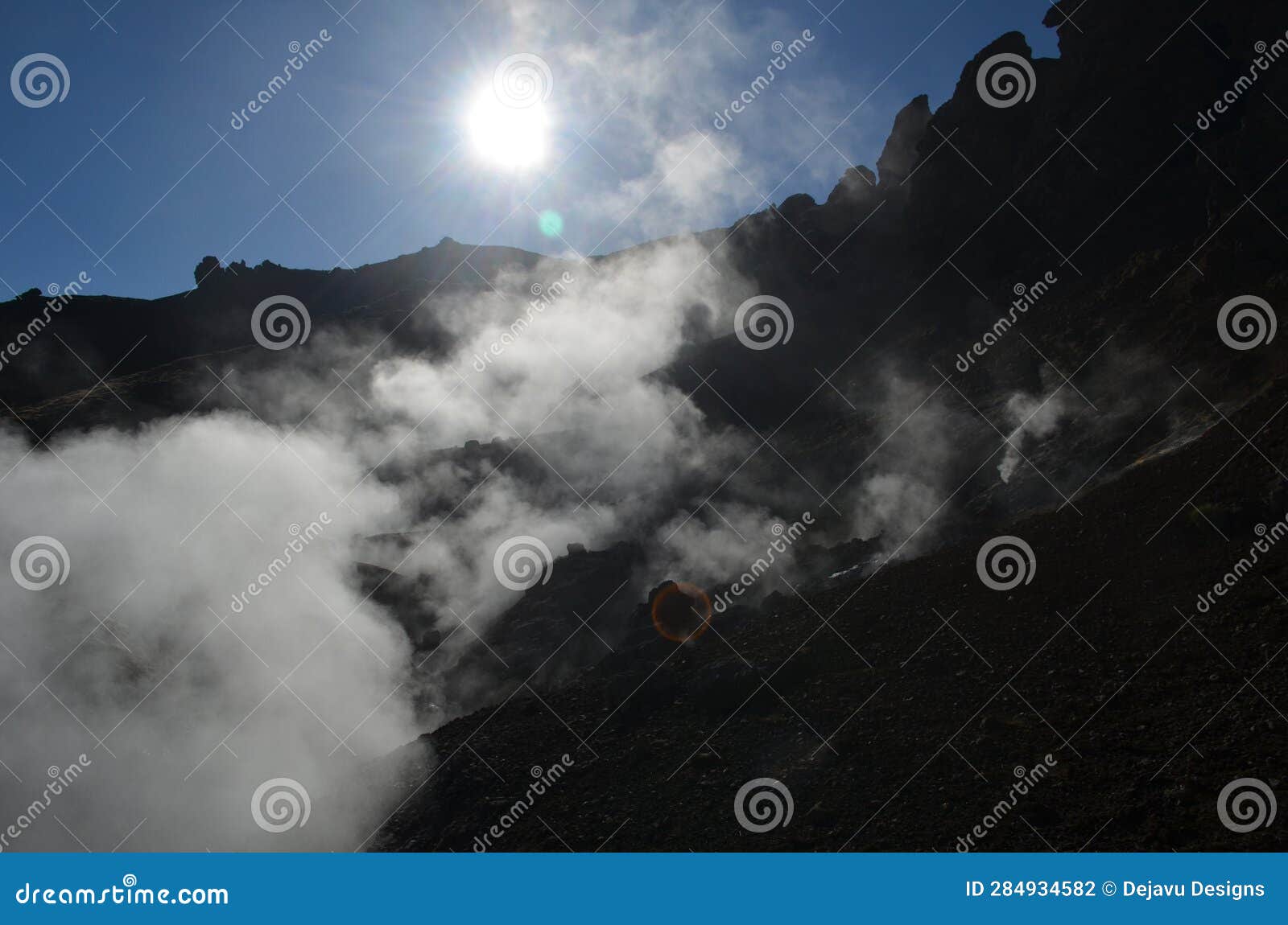 Sun Shining on Volcanic Rock with Steam Rising Stock Photo - Image of ...