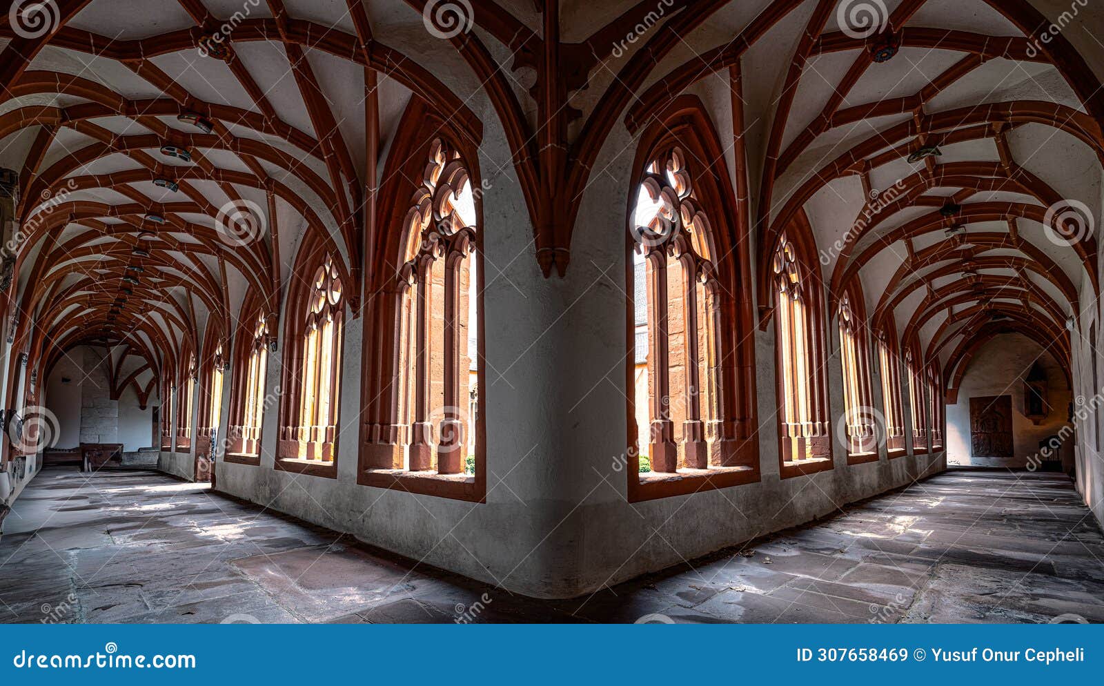 Gothic Architecture Showcased in Sunlit Corridor of Medieval Monastery ...