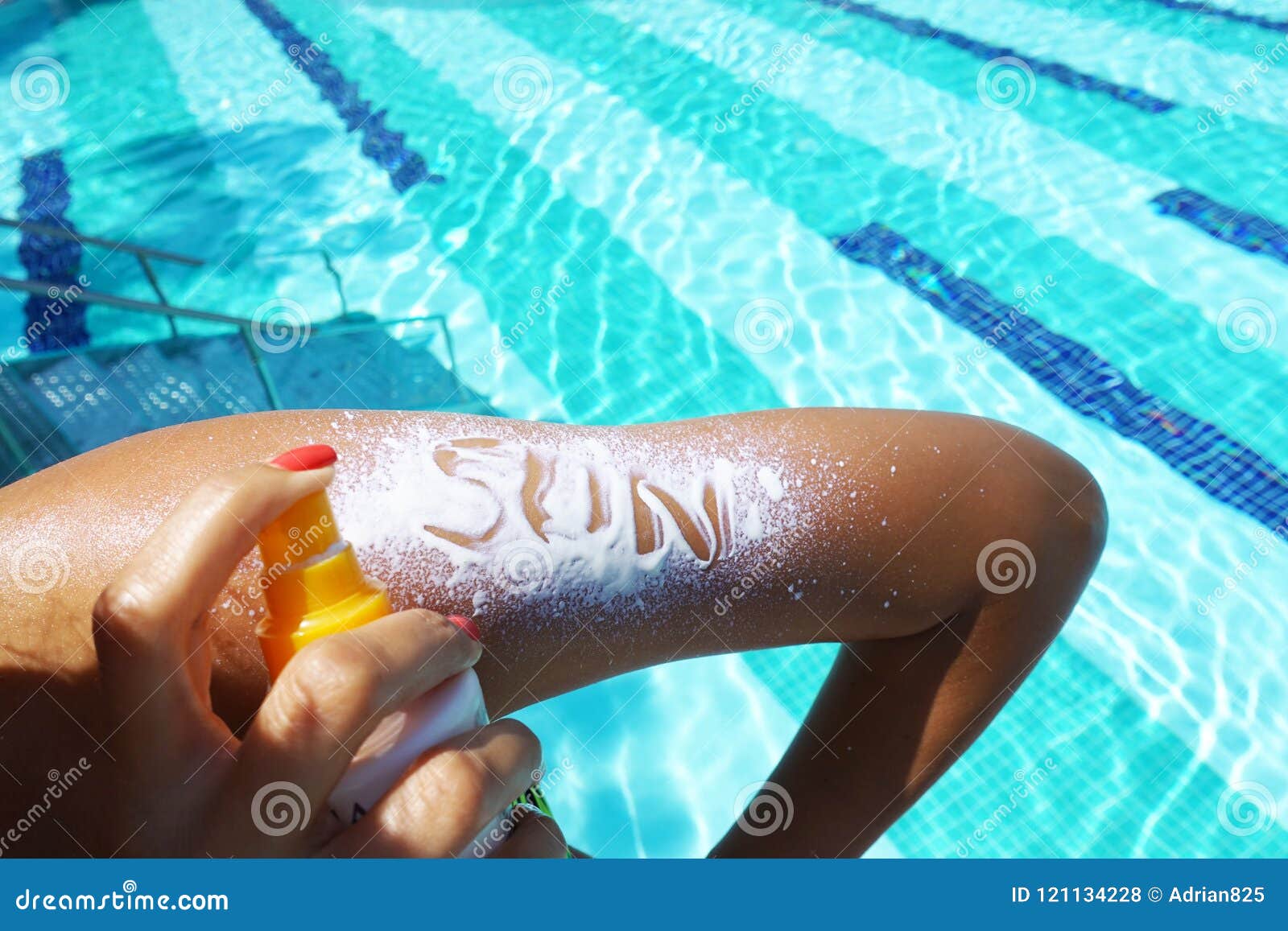 Sun Text on Sunscreen Applied with Spray on Woman Arm at Poolside Stock ...