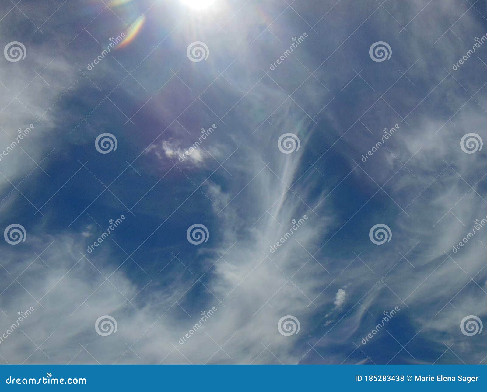 Sun and Wispy Clouds stock photo. Image of universe - 185283438