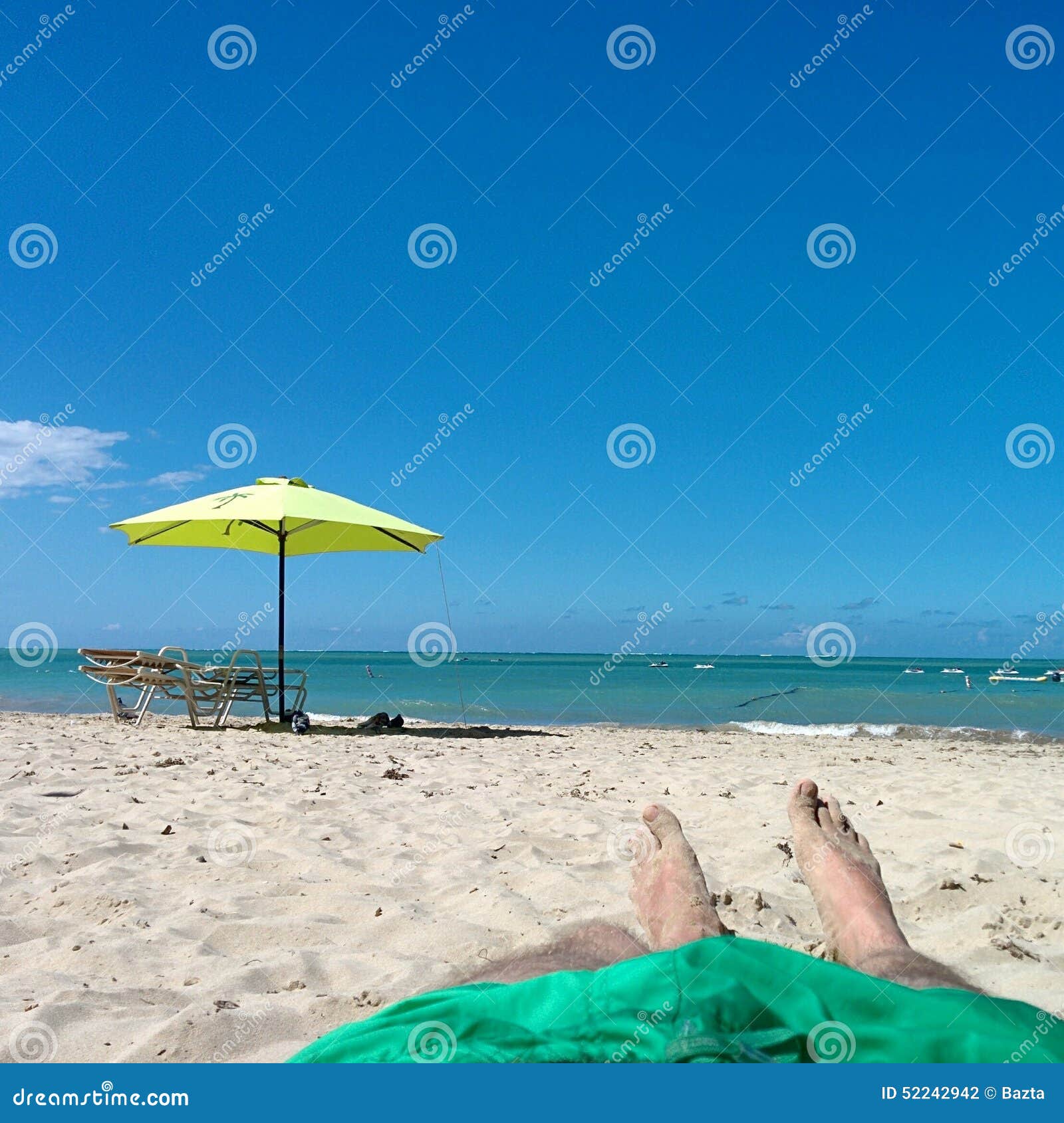 Sunbathing on the beach stock photo. Image of foot, square - 52242942