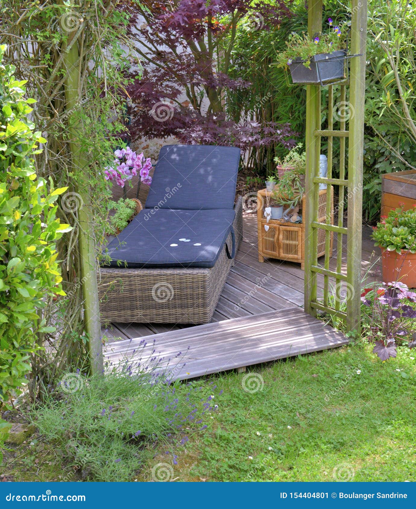 Sunbathing on a Wooden Terrace in a Garden Stock Image - Image of ...
