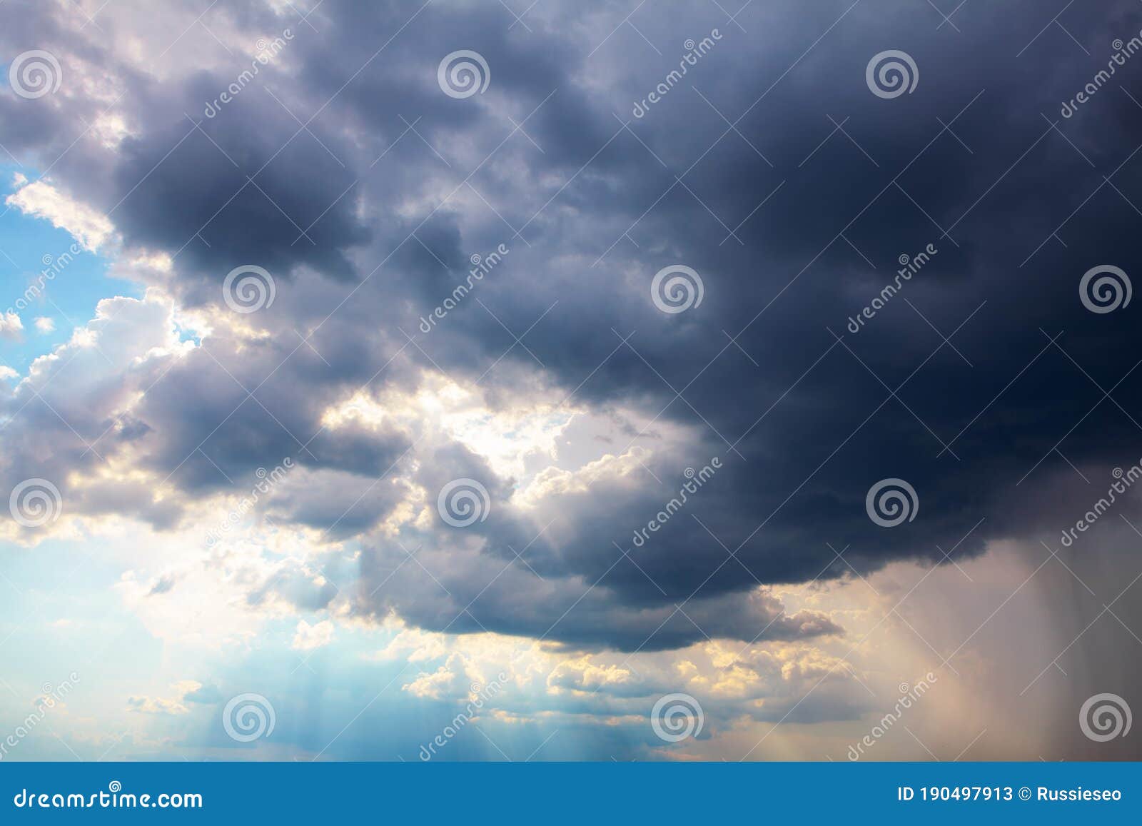 Sunbeam through the clouds stock image. Image of beam - 190497913