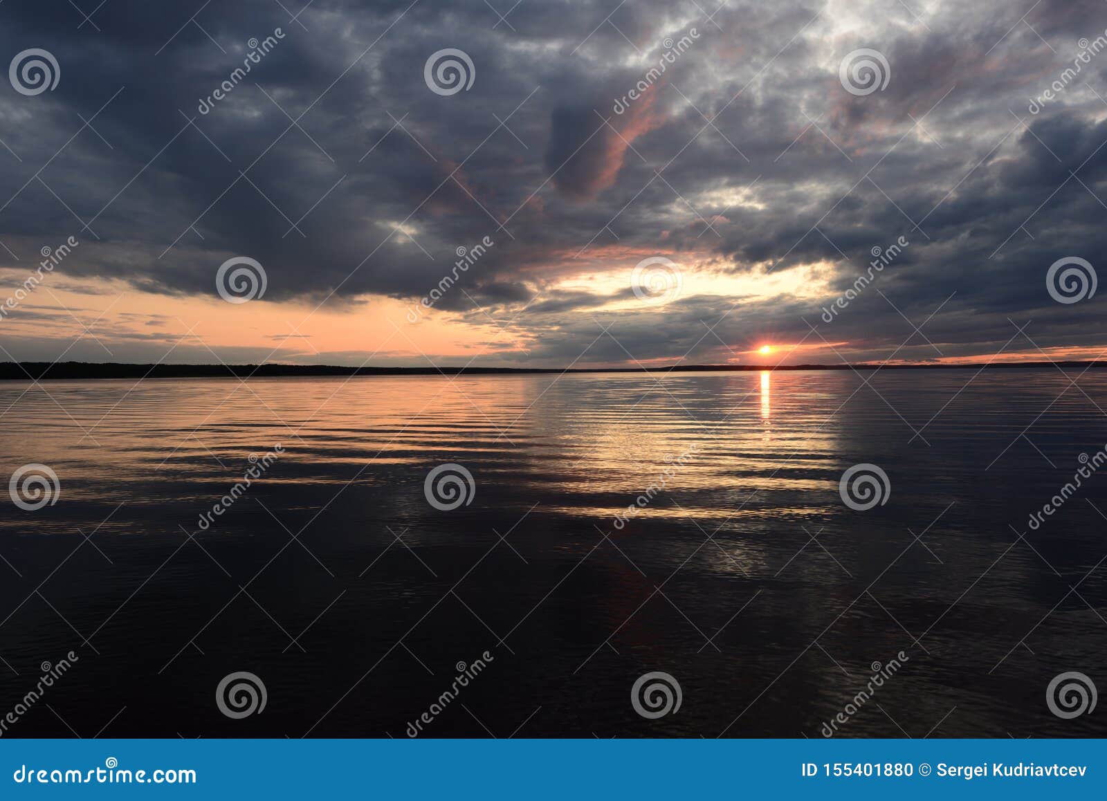 Sunbeam at Sunset from the Thick Dark Clouds of the Sky on the Surface ...