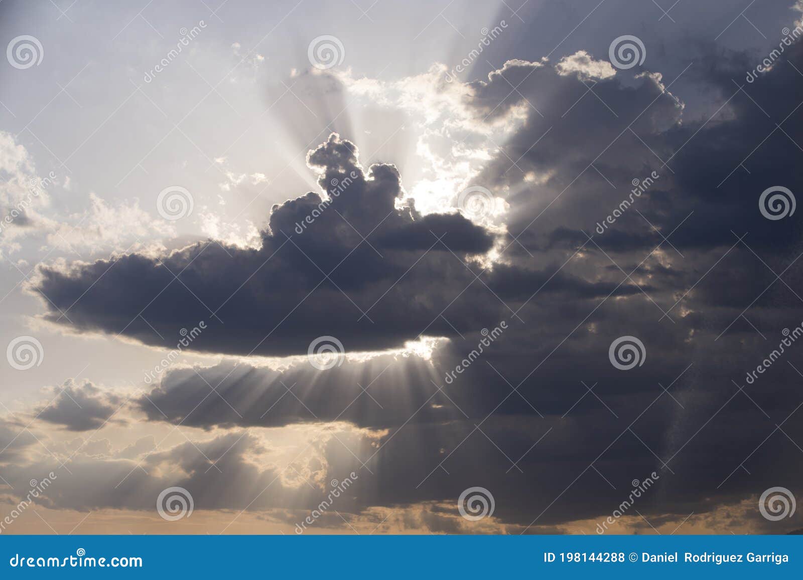 Sunbeams among the clouds stock photo. Image of mystic - 198144288