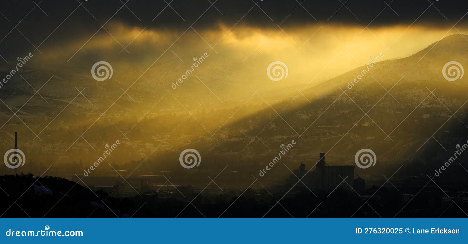 Sunbeams Sunlight Streaming Down on Town with Mountains Stock Image ...
