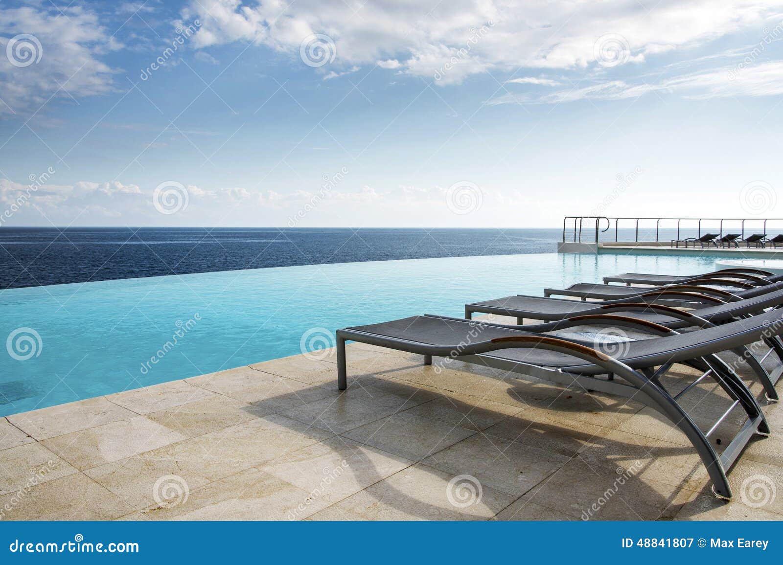 Sunbeds by Empty Infinity Pool Stock Image - Image of relaxation, ocean ...