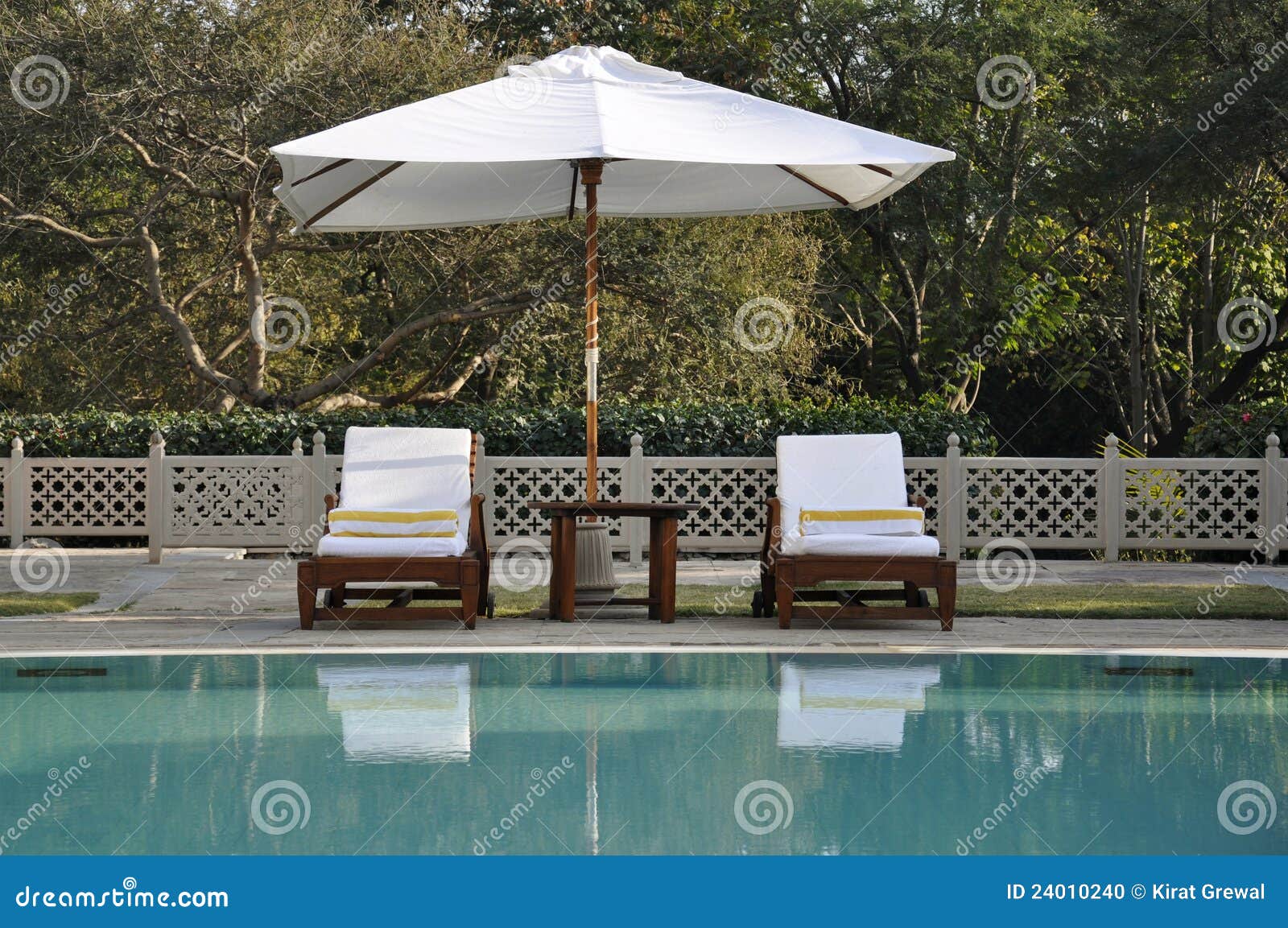 Sunbeds by a Swimming Pool Amidst Greenery Stock Photo - Image of ...