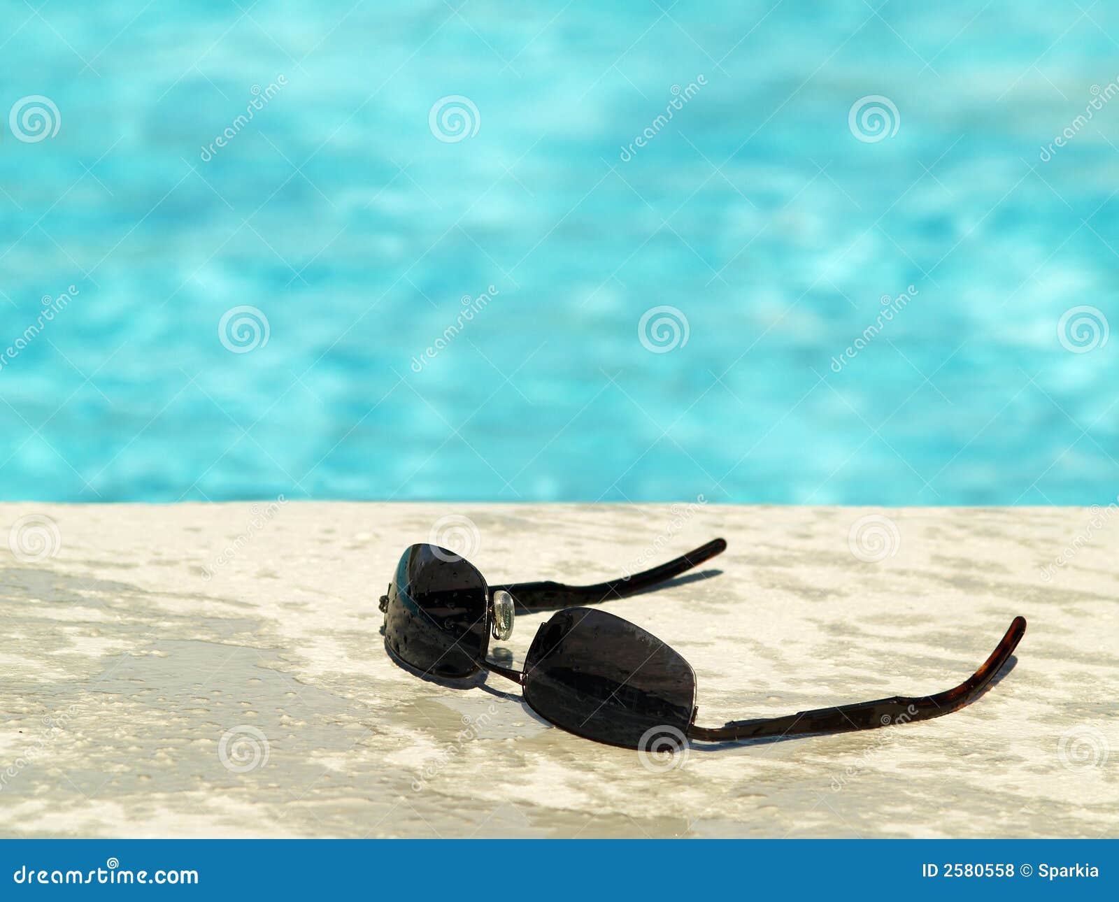 Sunglasses by the pool stock photo. Image of swimming - 2580558