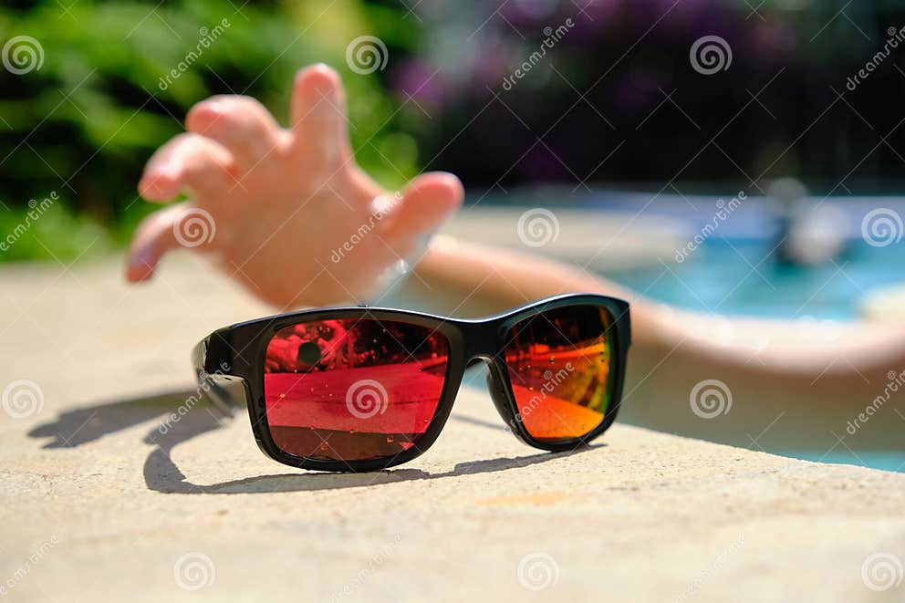 The sunglasses by the pool stock photo. Image of beach - 288276232