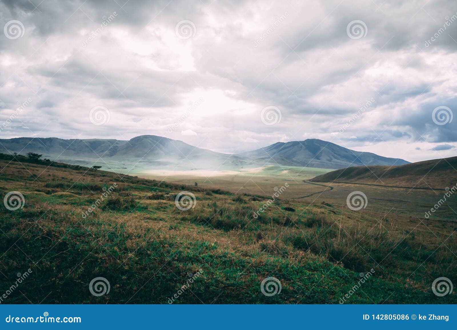 Sun Beam through Clouds on Grass Field Stock Photo - Image of sunlight ...