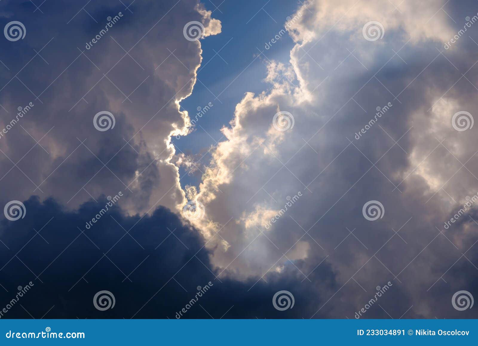 Sunlight Breaking through White and Dark Clouds in the Blue Sky Stock ...