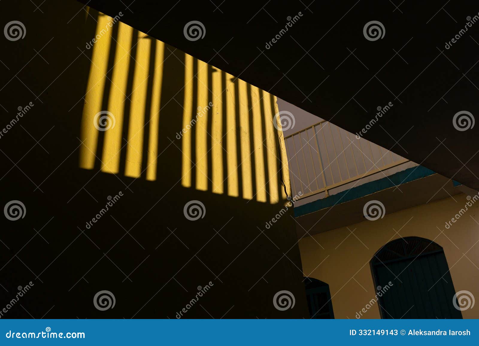 Sunlight Casts Dramatic Shadows on a Yellow Wall, Creating a Striking ...