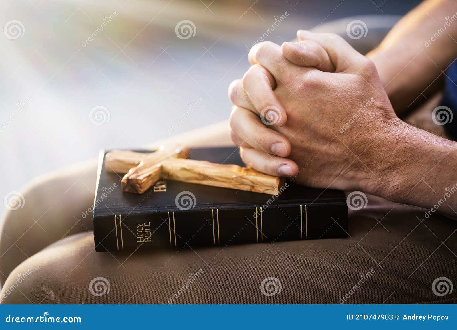 Man`s Praying Hand on Bible Stock Image - Image of book, capital: 210747903