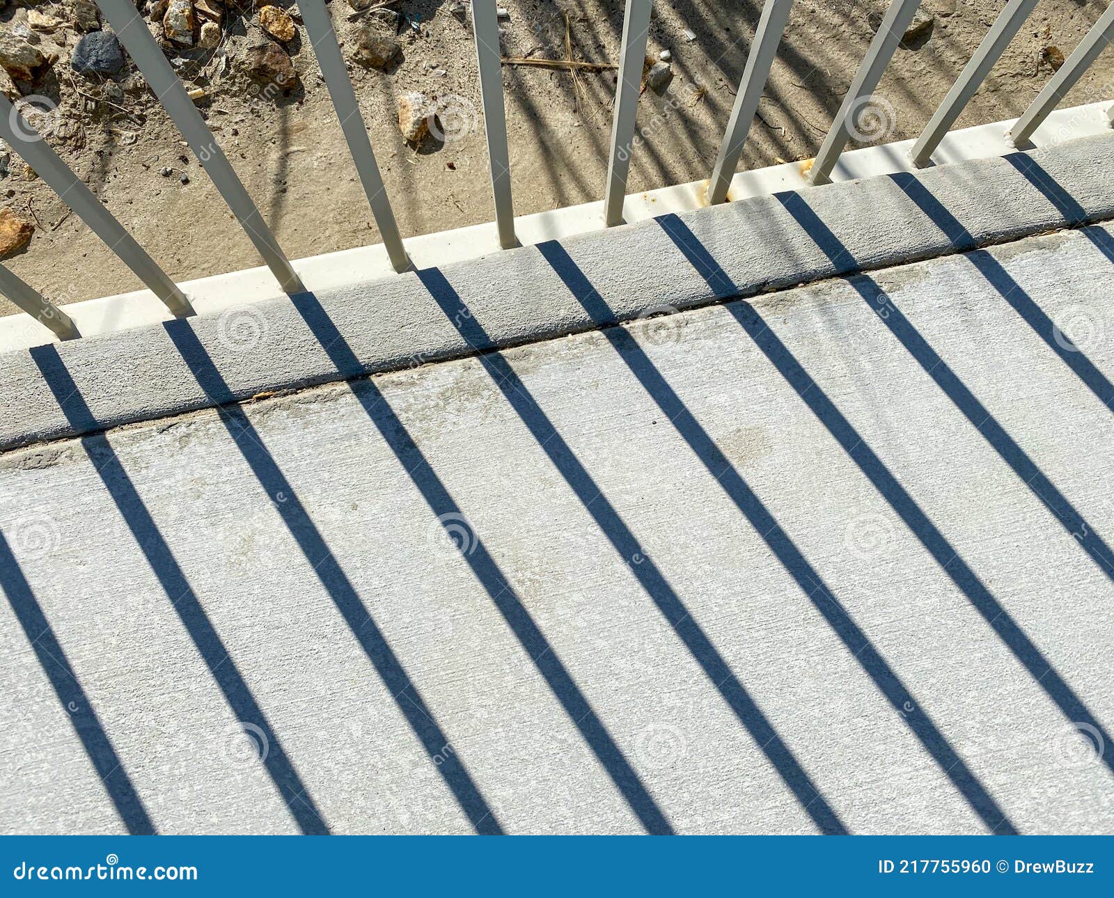 Sunlight through a while Metal Fence with Shadows Casting on Concrete ...