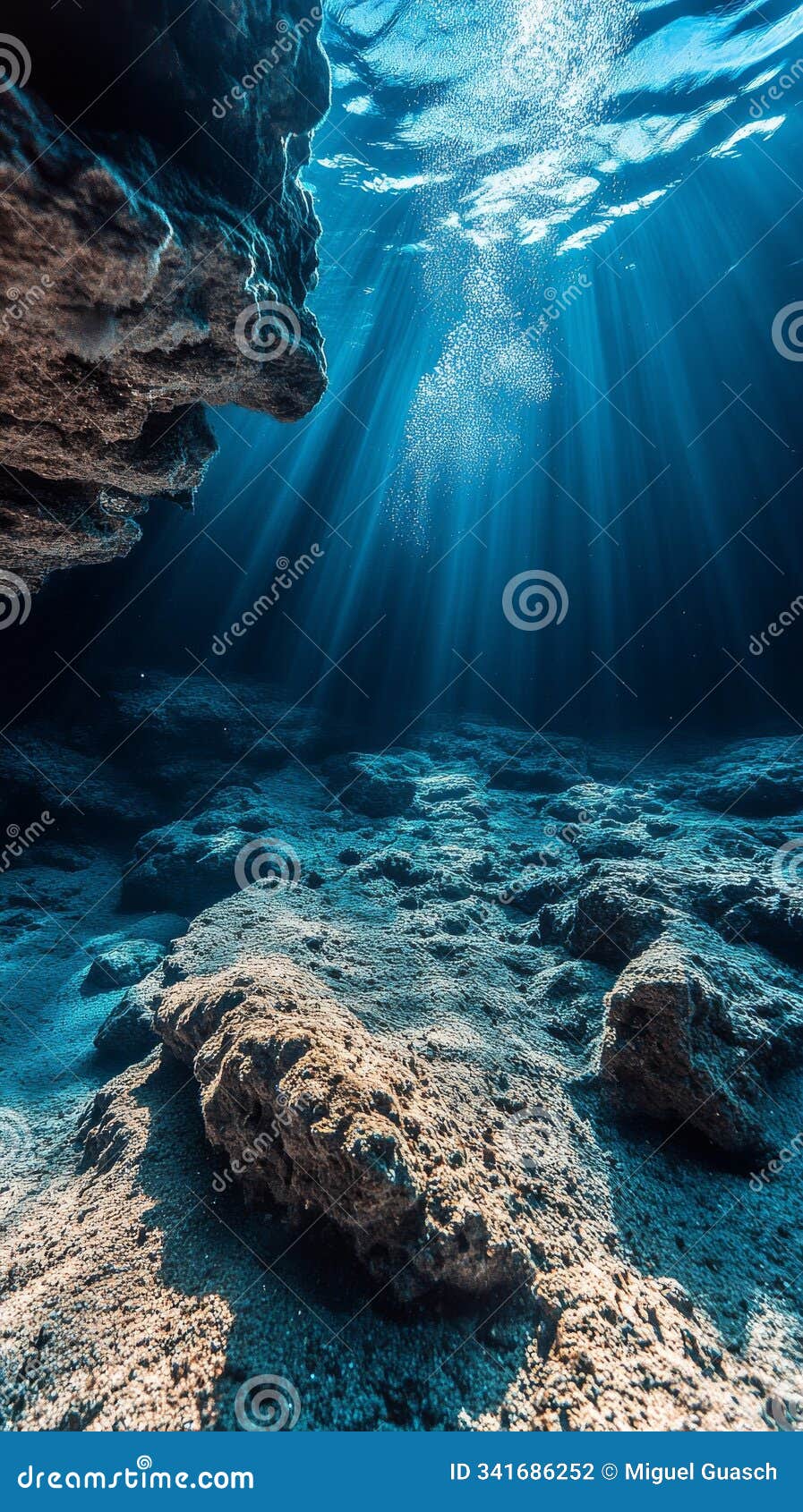 Sunbeams Shining through the Surface of Water Illuminating Rocks on the ...