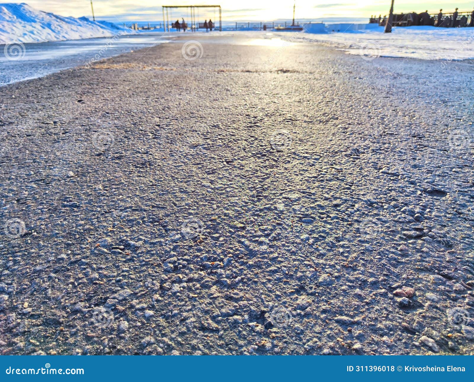 Sunlight Reflecting on a Wet Asphalt Road. Sun Peeks Over a Ice Covered ...