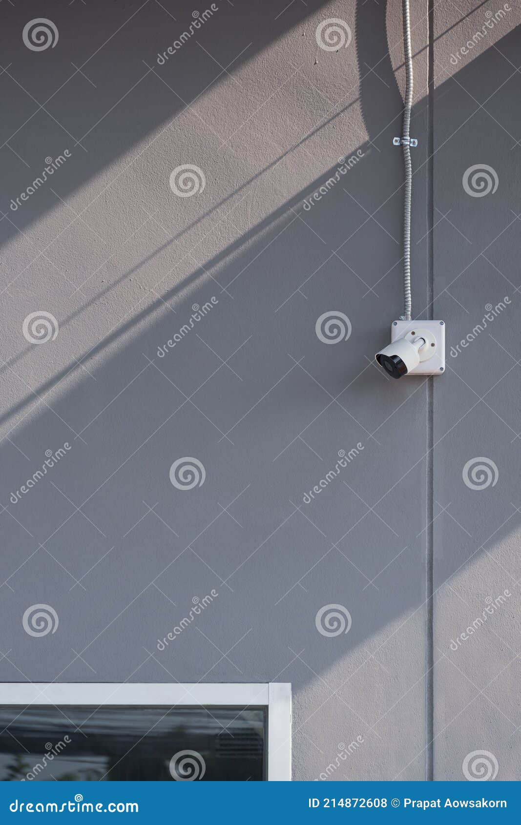 Security Camera with Flexible Metal Conduit on Gray Cement Wall in ...