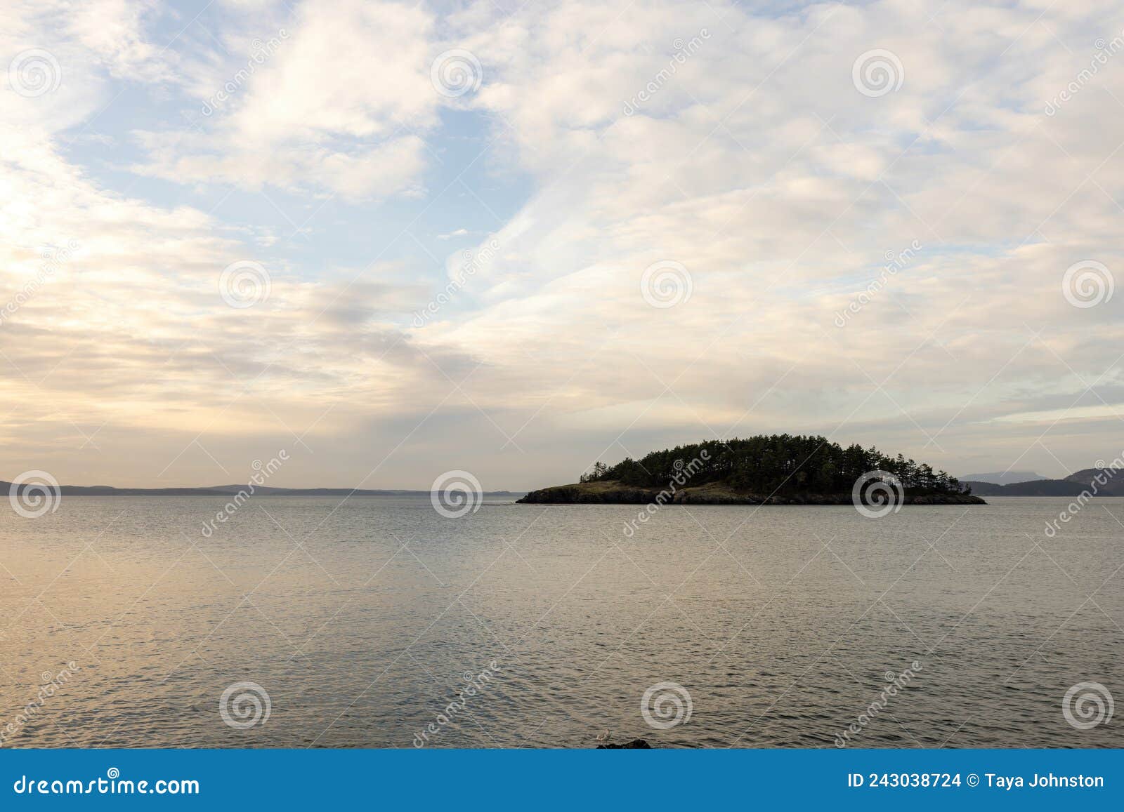 Sunlight Streaming through Clouds Reflecting in Calm Ocean Stock Photo ...