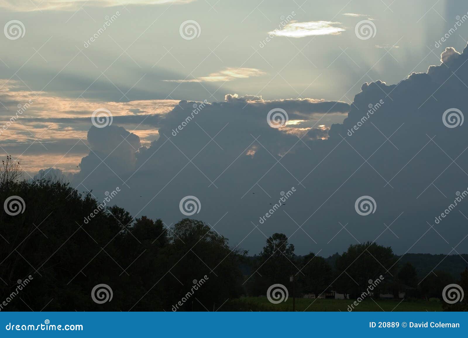 Sunlight Streaming Over Storm Clouds Stock Image - Image of sunset ...