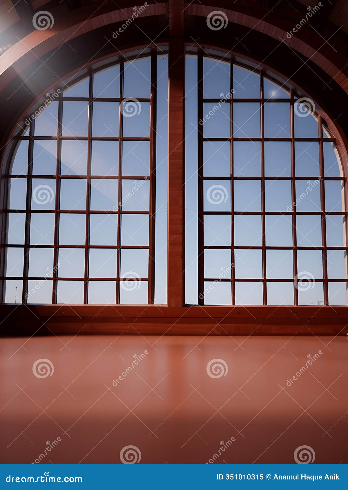 Sunlight Streams through a Large Arched Window with a Grid Pattern ...