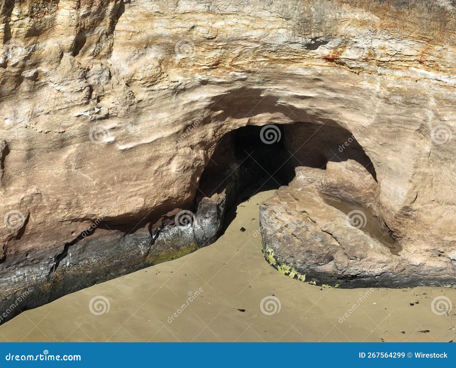 Sunlit Cave in the Cliff with a Smooth Surface, Sandy Ground Stock ...