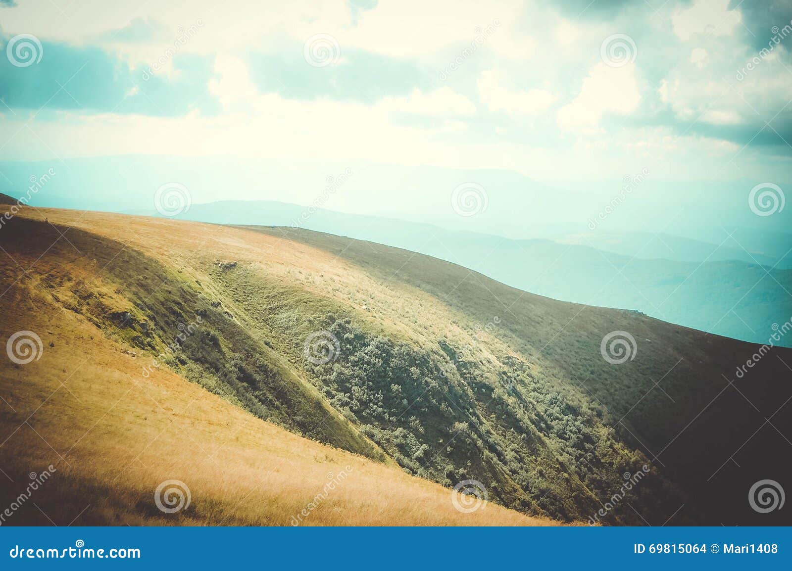 Sunlit field in mountains stock photo. Image of field - 69815064