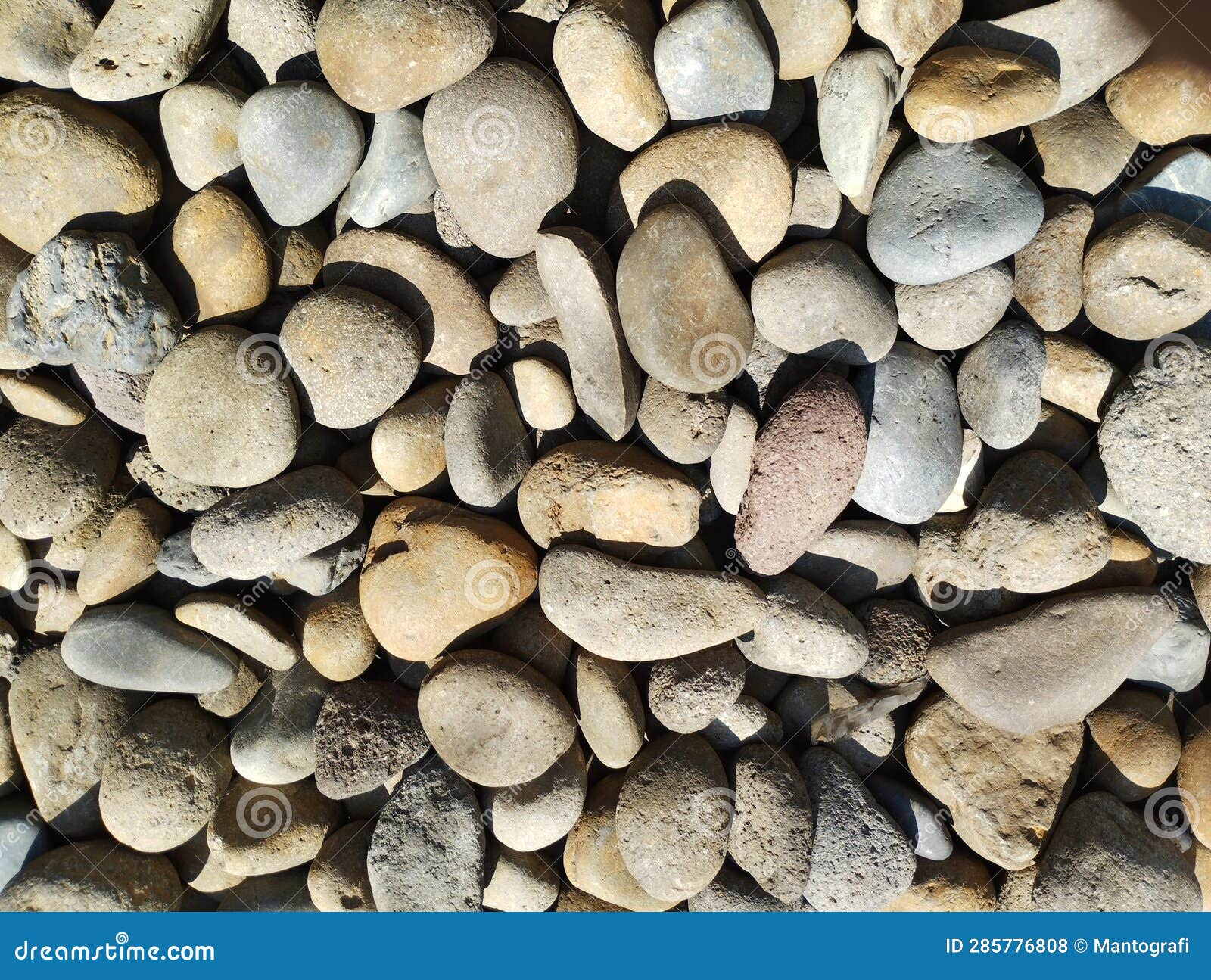 Sunlit Round Pebble Rocks, Textures are Evident, Shadows Create ...