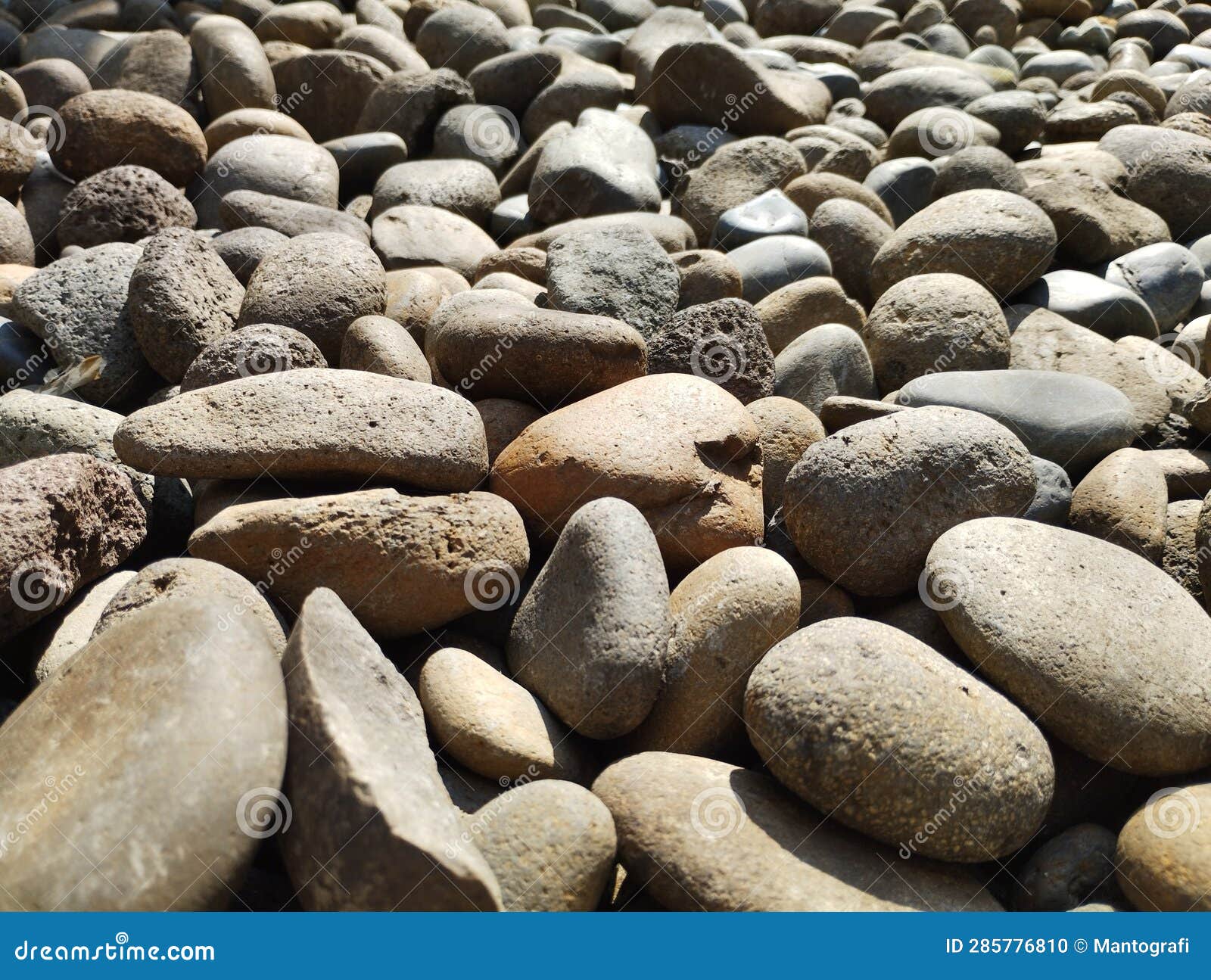 Sunlit Round Pebble Rocks, Textures are Evident, Shadows Create ...