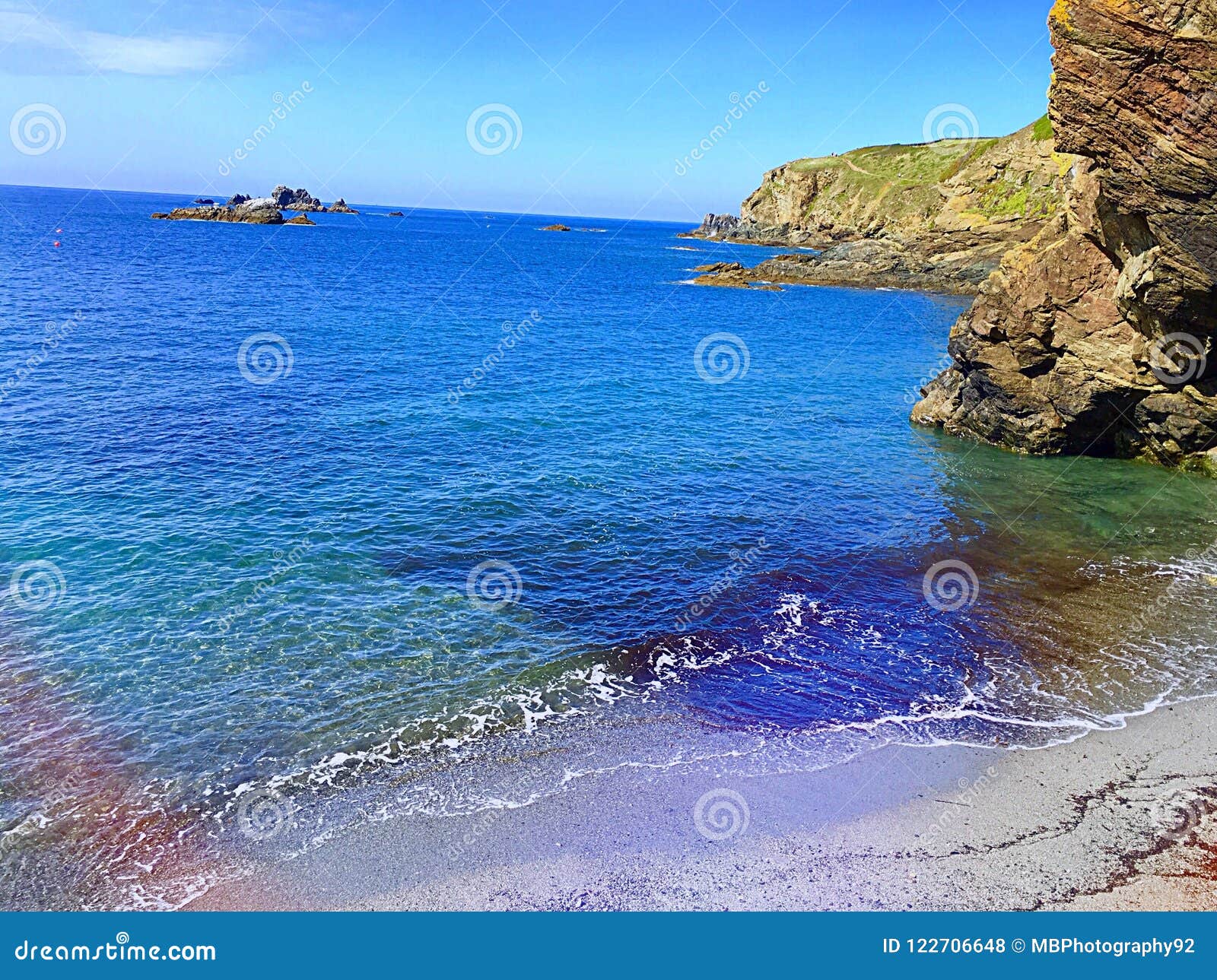 Sunny beach in Cornwall stock photo. Image of cliff - 122706648