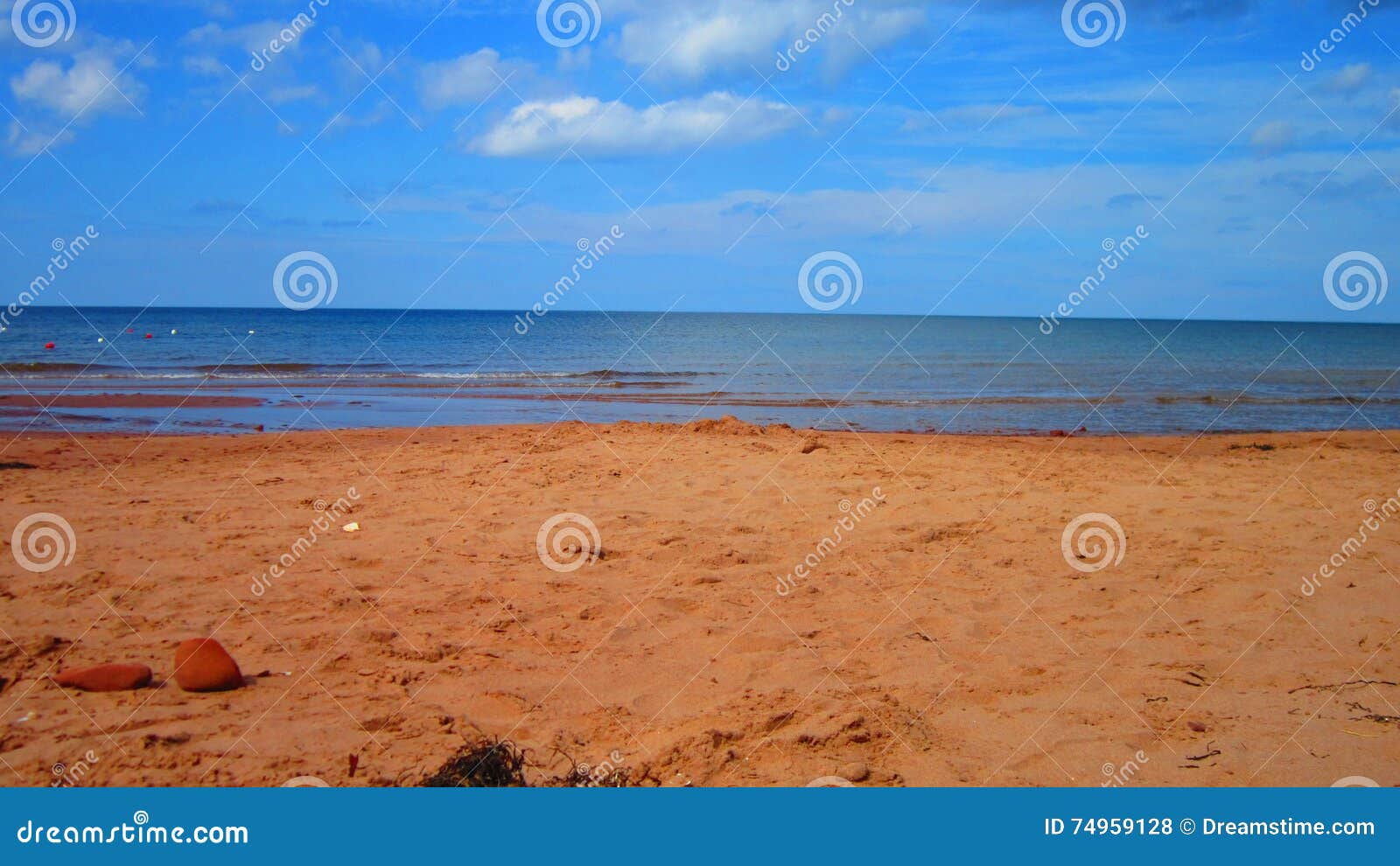 Sunny Beach Day stock photo. Image of sunny, rocks, clouds - 74959128