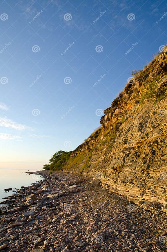 Sunny Cliff Steep at a Stony Coast Stock Photo - Image of baltic, blue ...