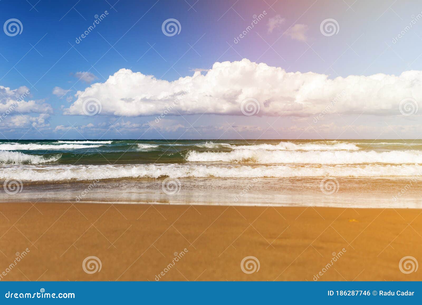 Sunny Day on the Beach with Big Waves and White Clouds Stock Photo ...