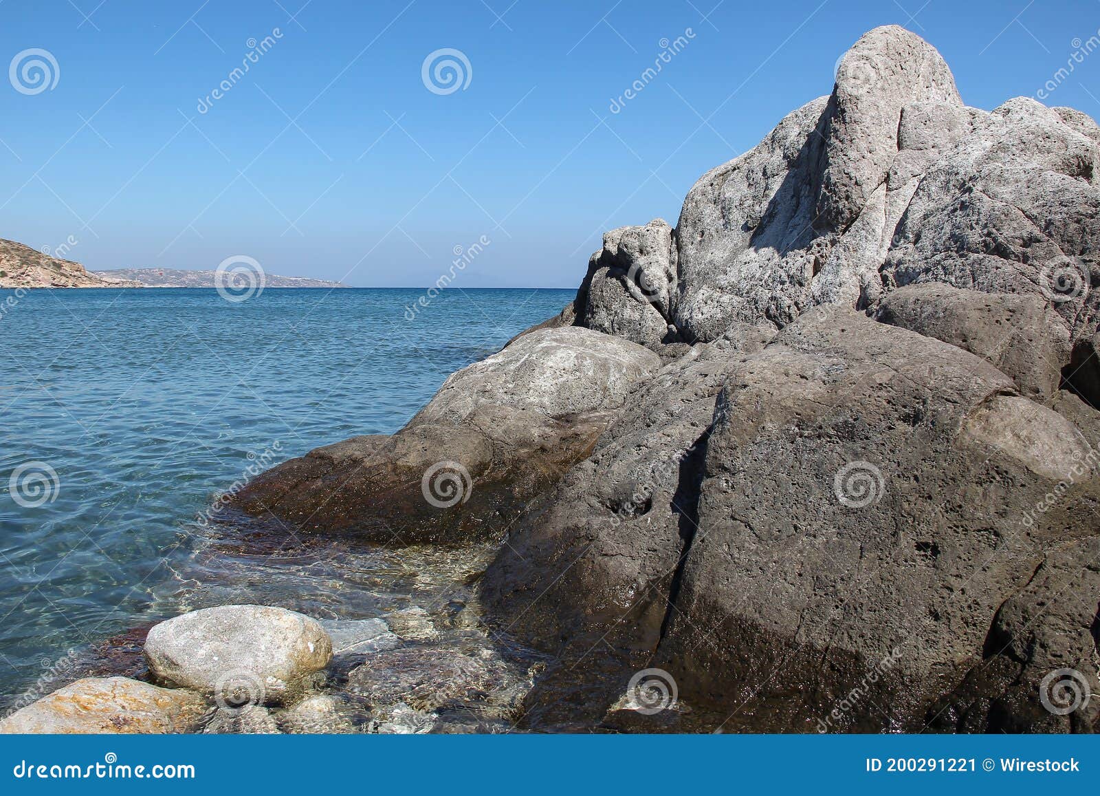 Sunny Scenery of a Rocky Beach with Big Grey Rocks Stock Image - Image ...