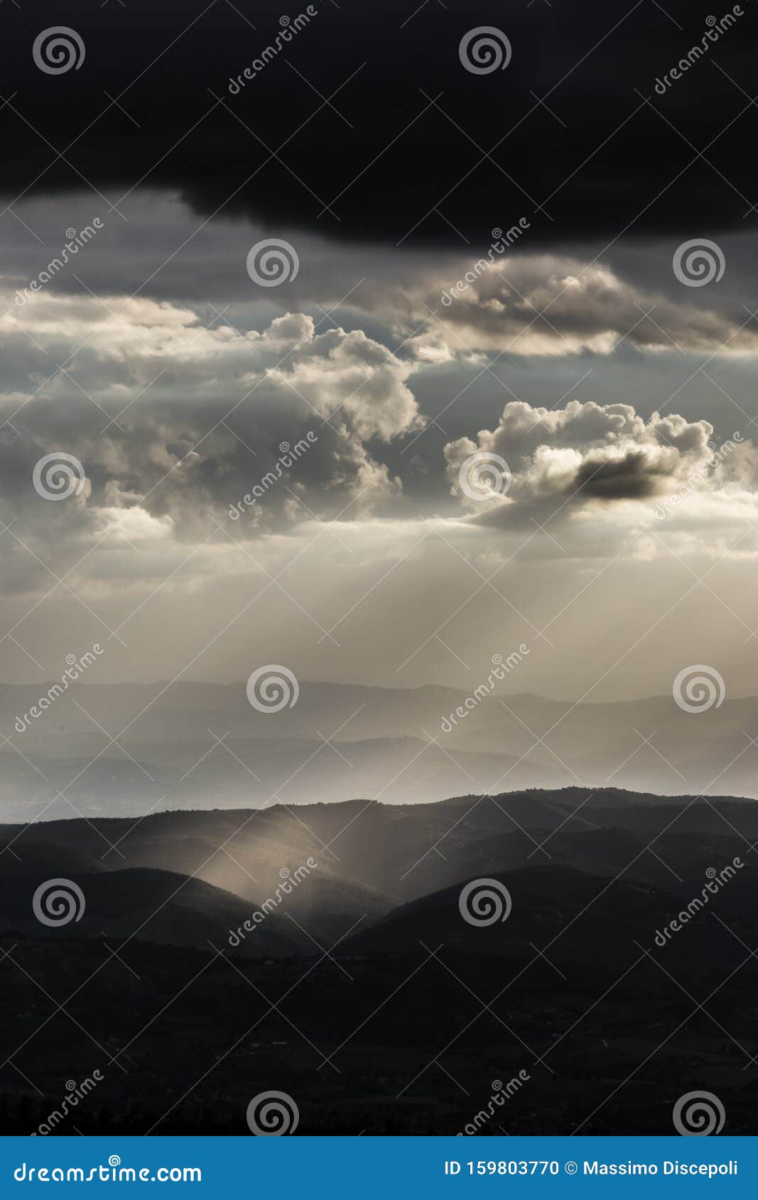 Sunray Shines through Clouds and Rain Over the Mountains in the Middle ...