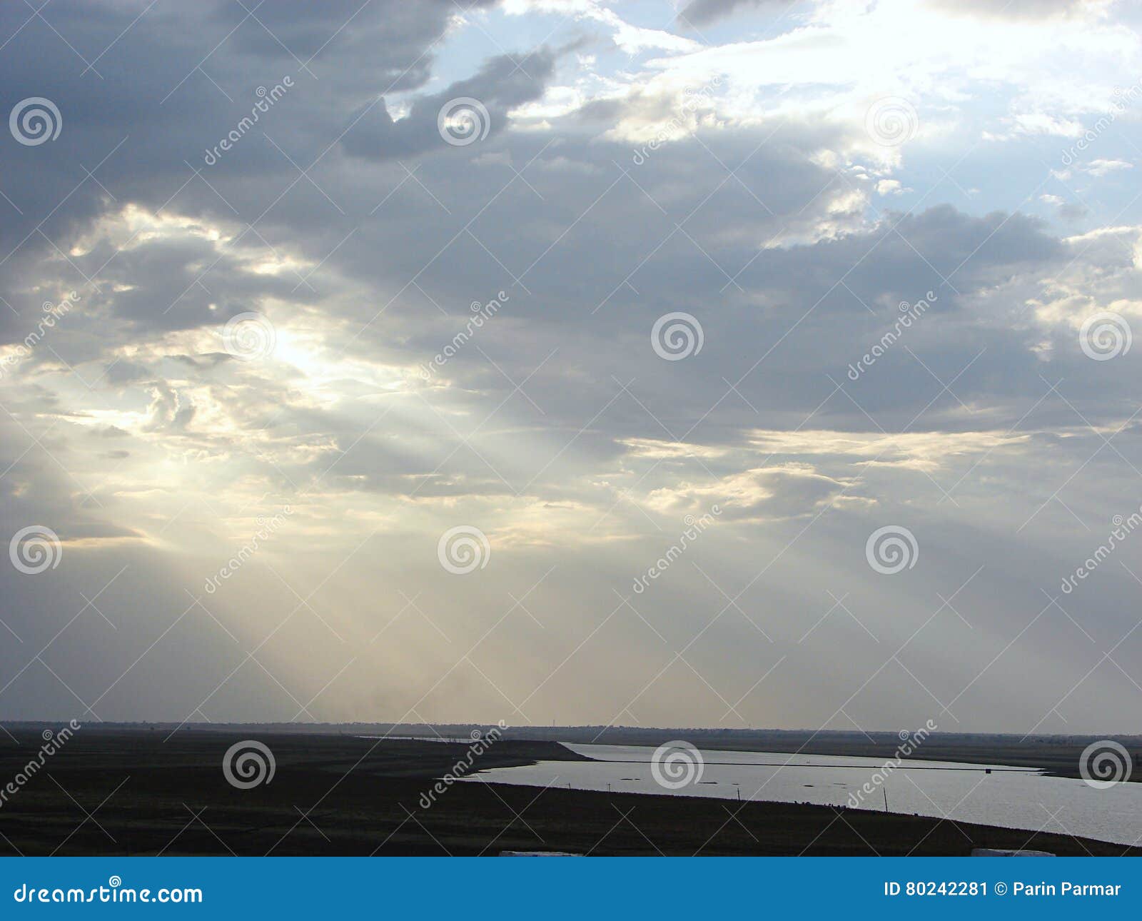 Sunrays through Clouds Spreading Over a River Stock Image - Image of ...