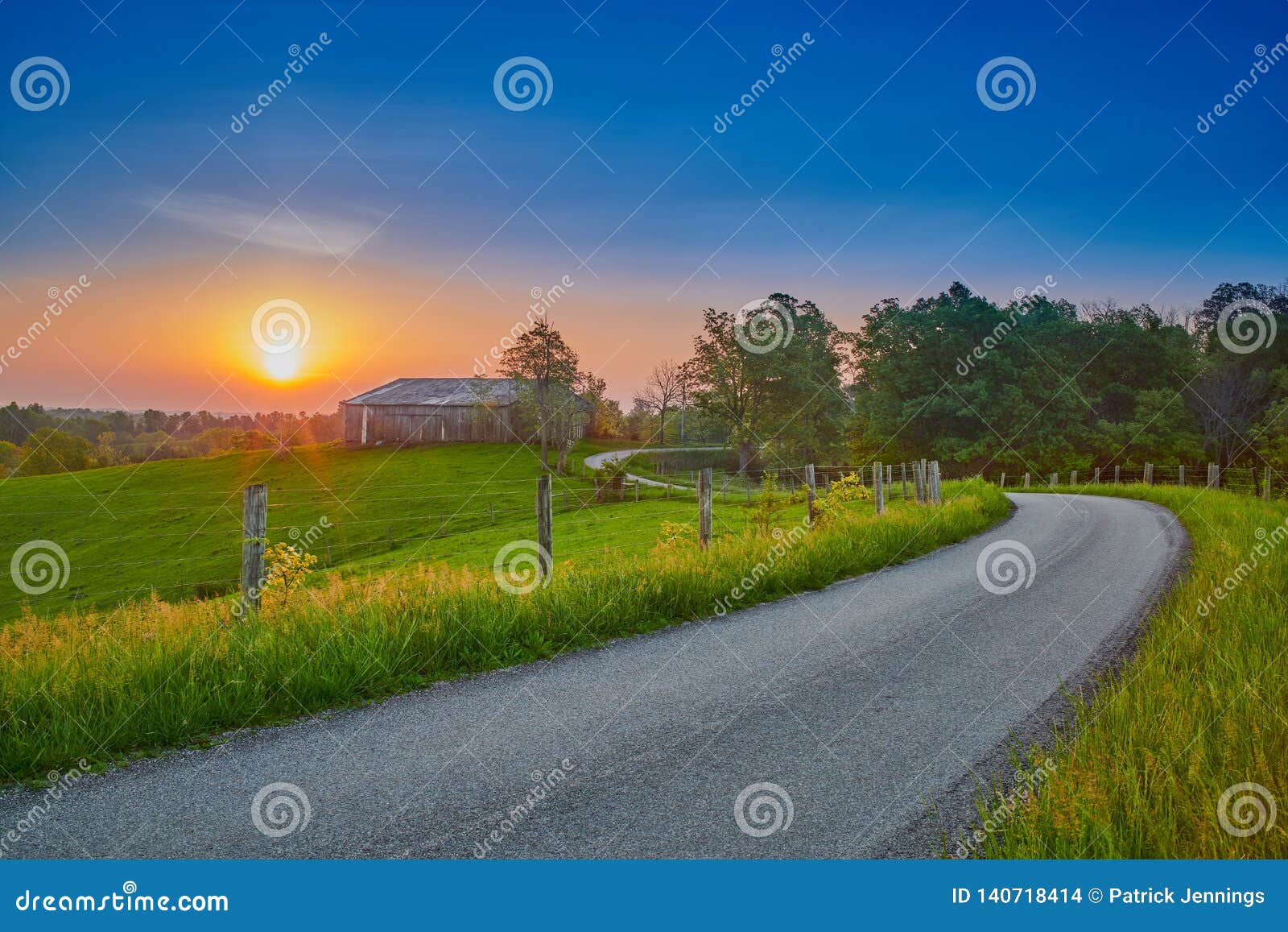 Sunrise Along a Counrty Road with Barn Stock Photo - Image of hills ...