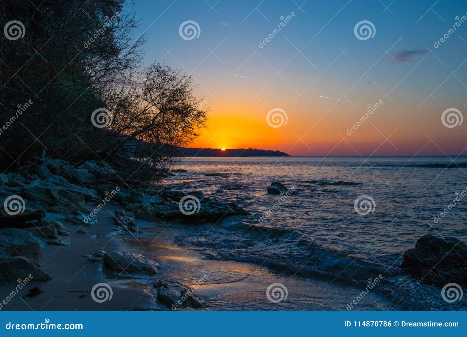 Sunrise on the Beach with Rocks and Trees Stock Photo - Image of island ...