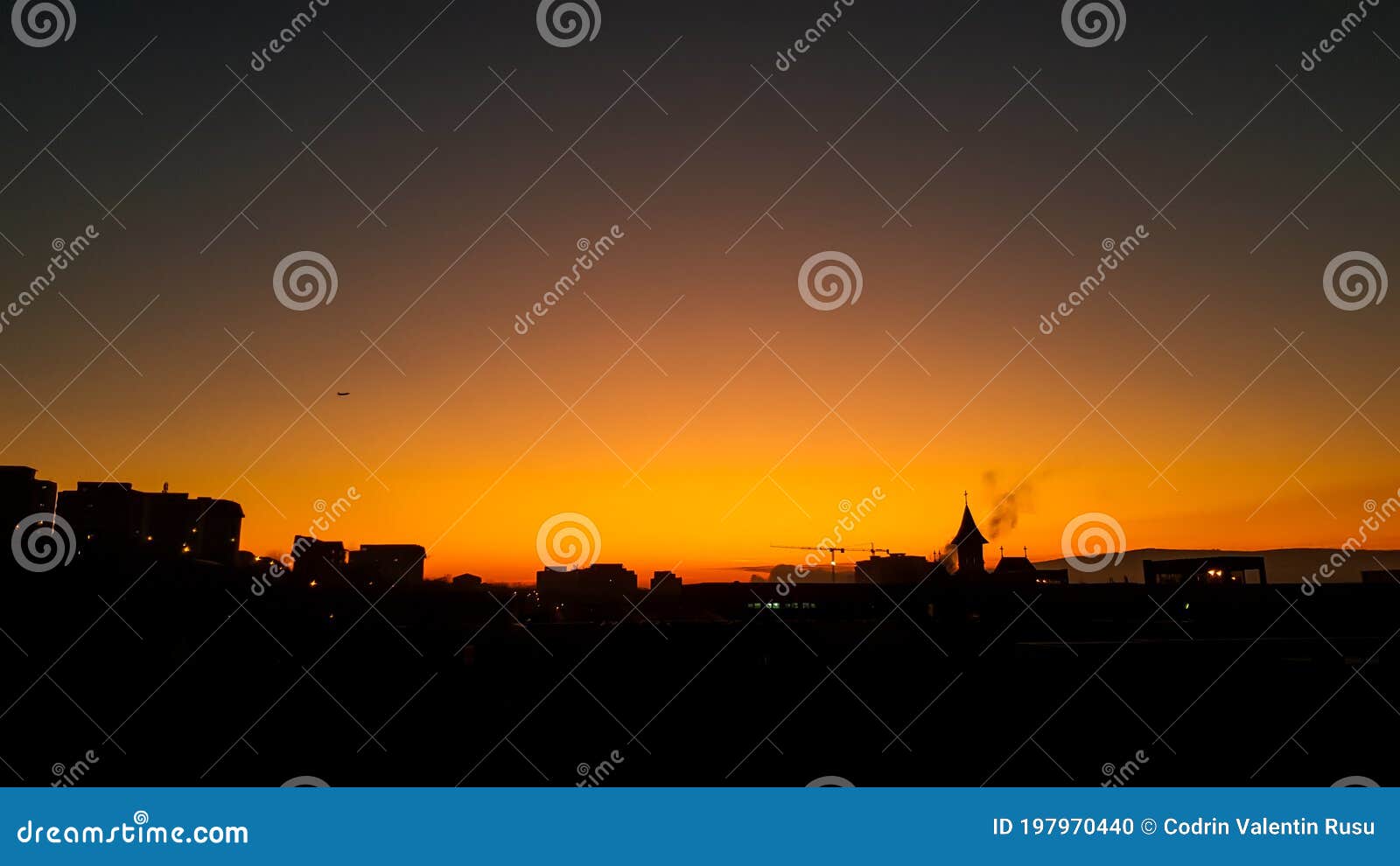 Sunrise with Clear Sky and Plane and Backlit City Landscape Editorial ...