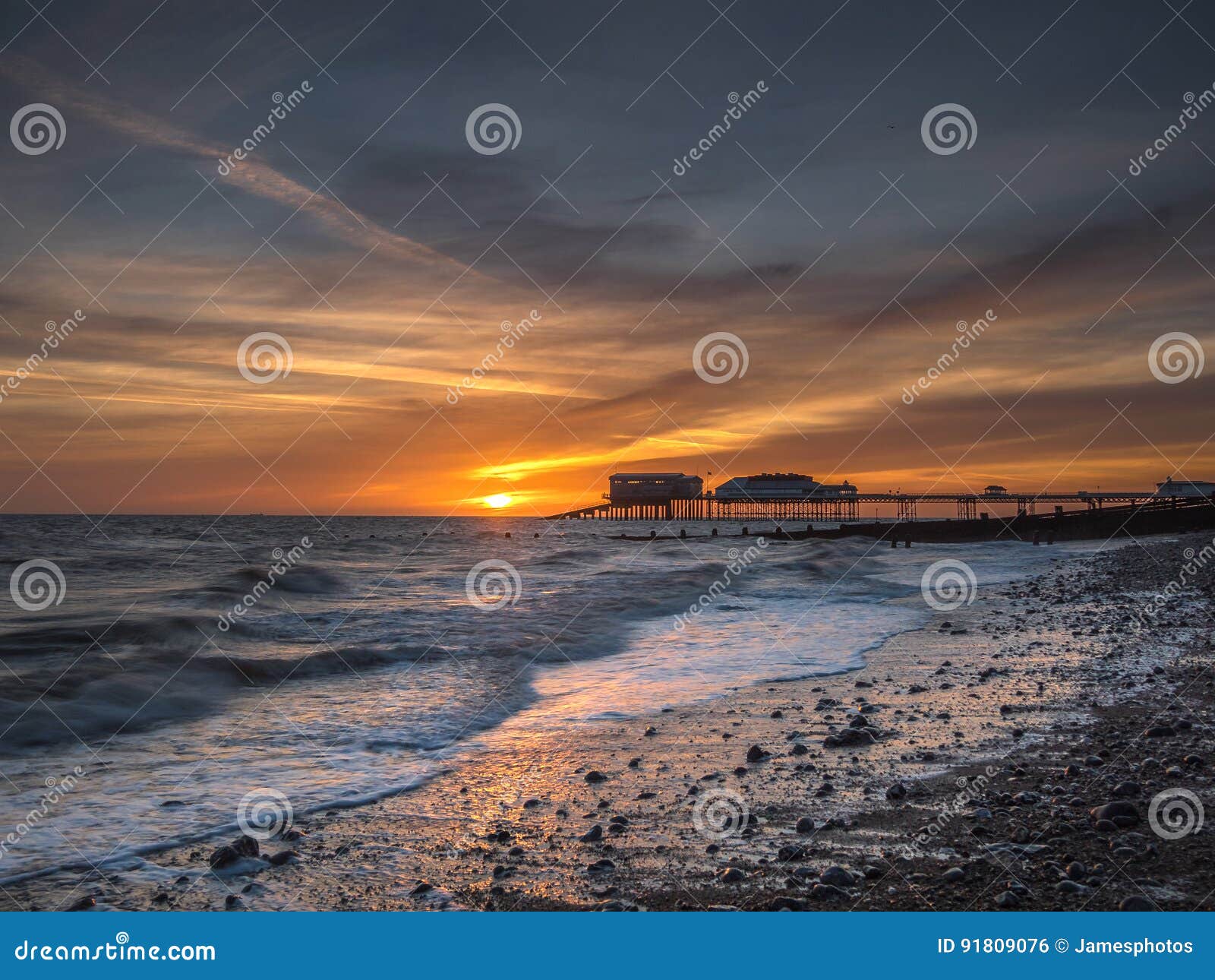 Sunrise at Cromer Beach stock photo. Image of boats, next - 91809076