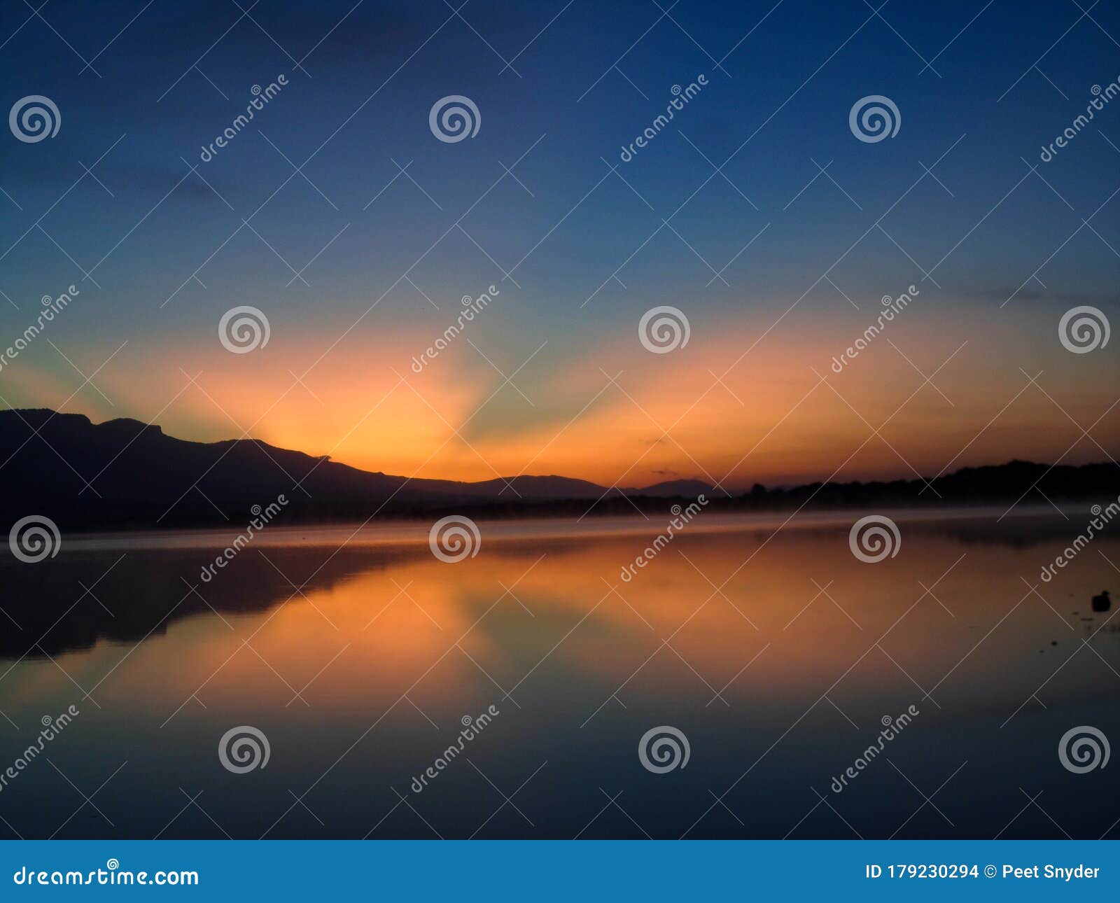 Sunrise Over a Lake with Water in Front Stock Photo - Image of morning ...