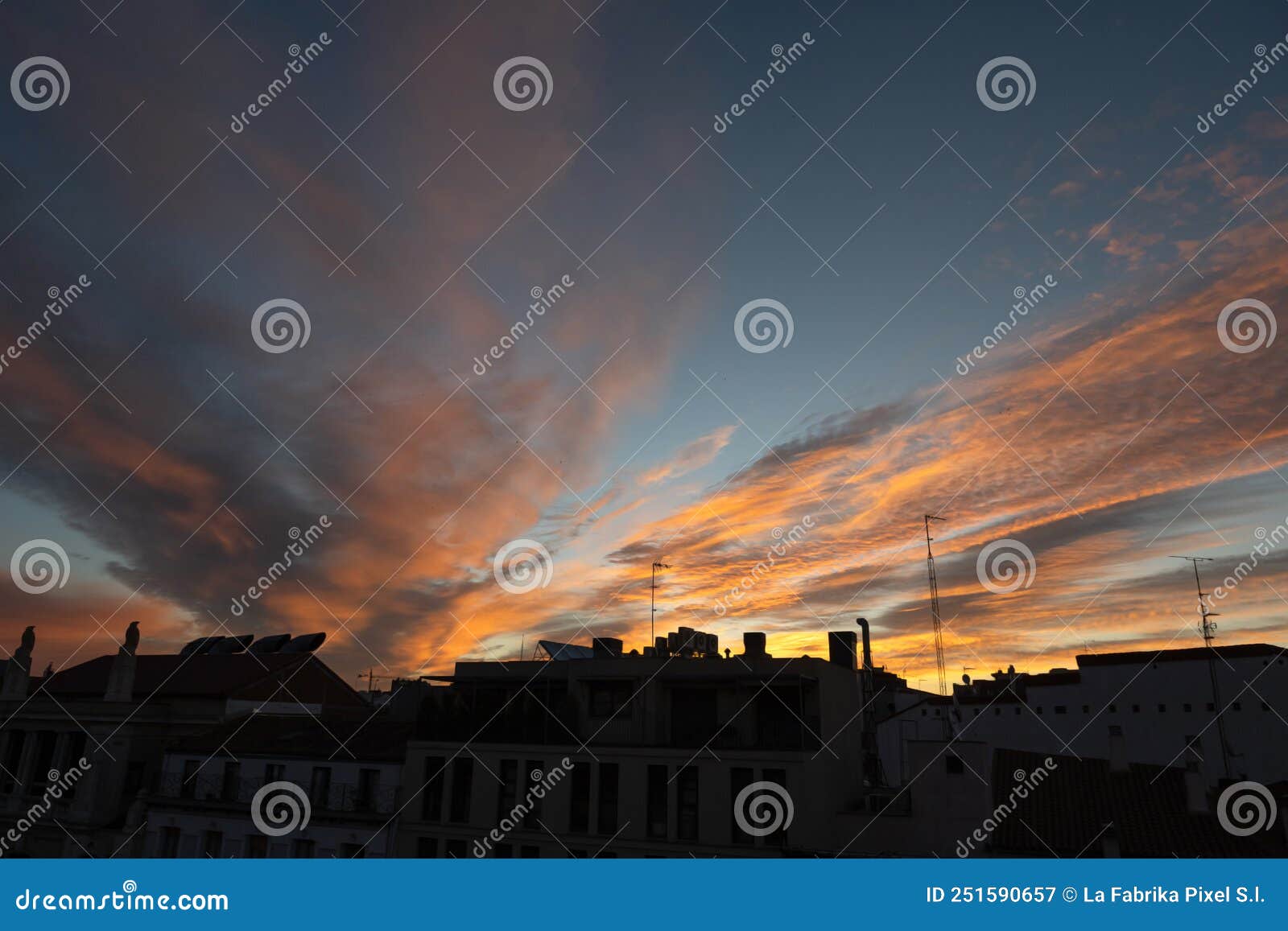 Sunrise over the rooftops stock image. Image of sunrise - 251590657