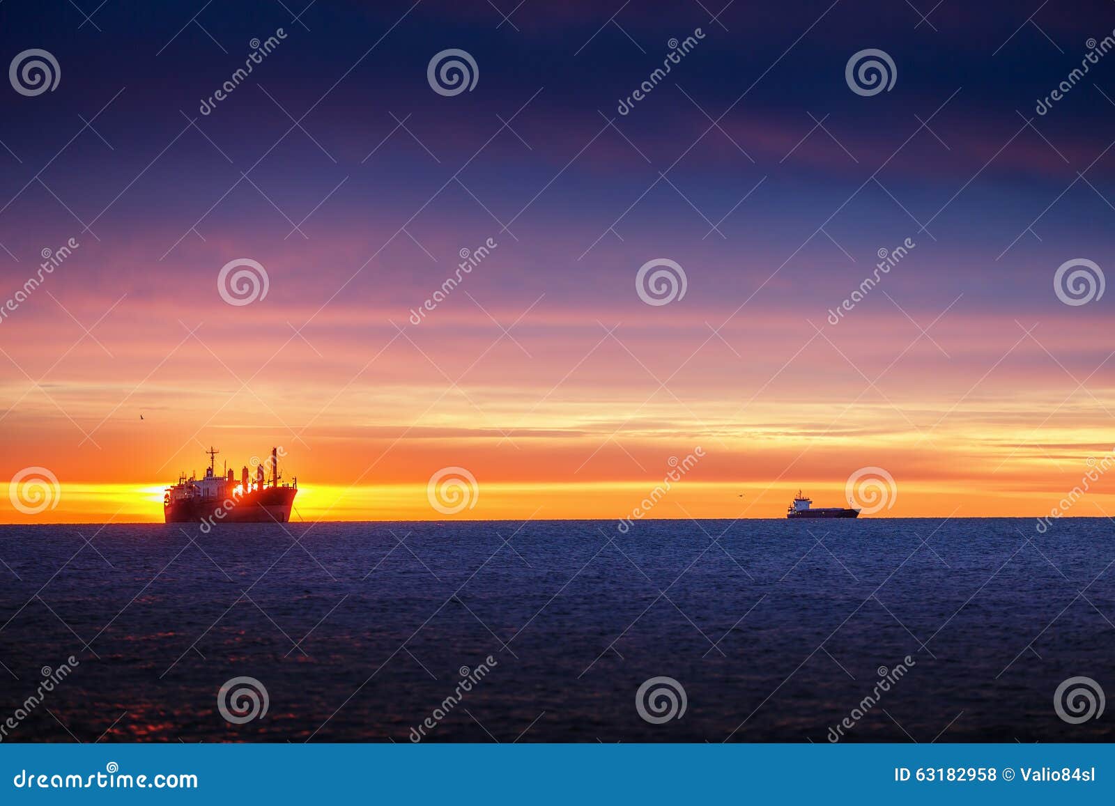 Sunrise Over the Sea and Sailing Cargo Ships Stock Photo - Image of ...