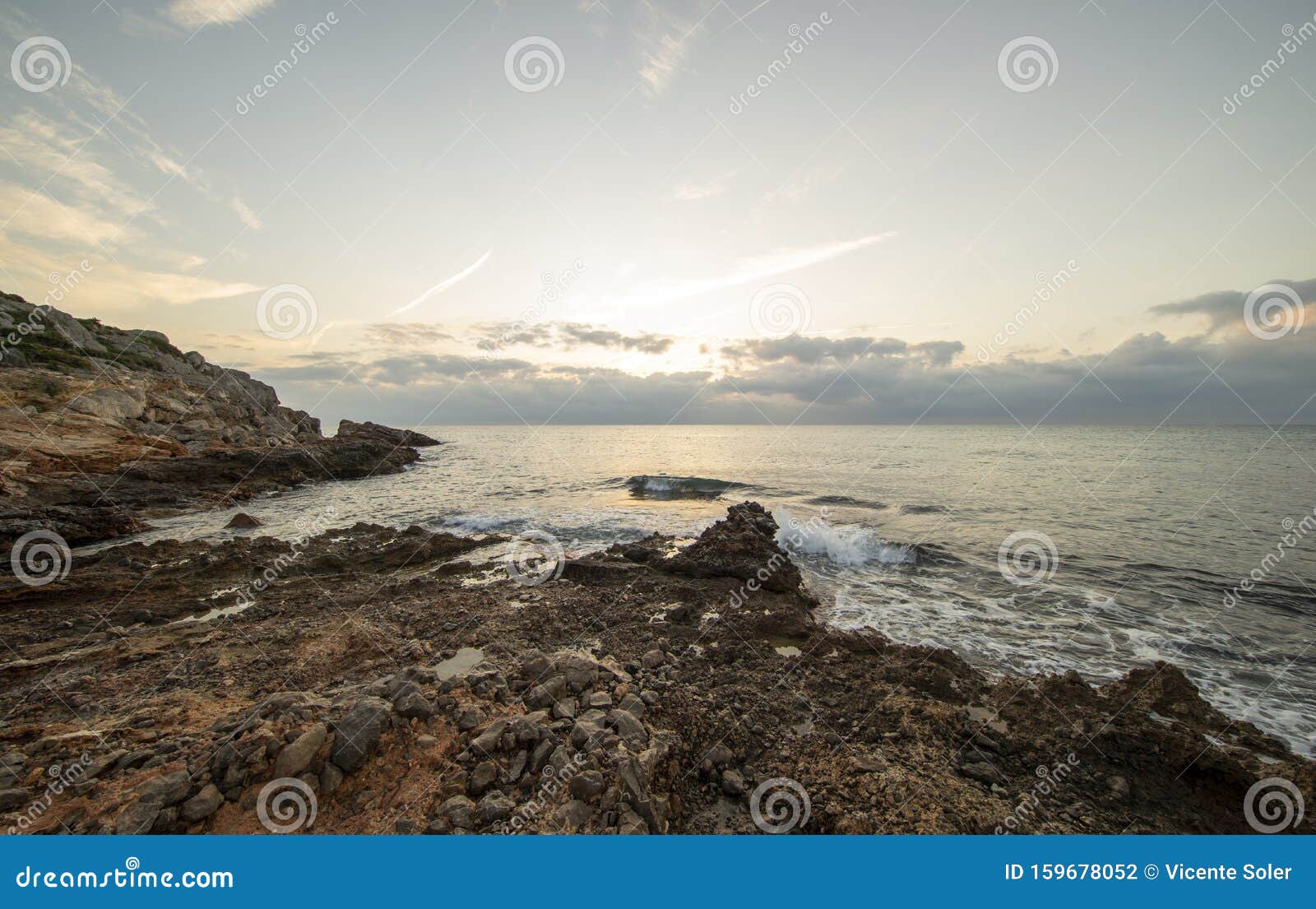 Sunrise between Rocks and the Oropesa Sea Stock Photo - Image of ...