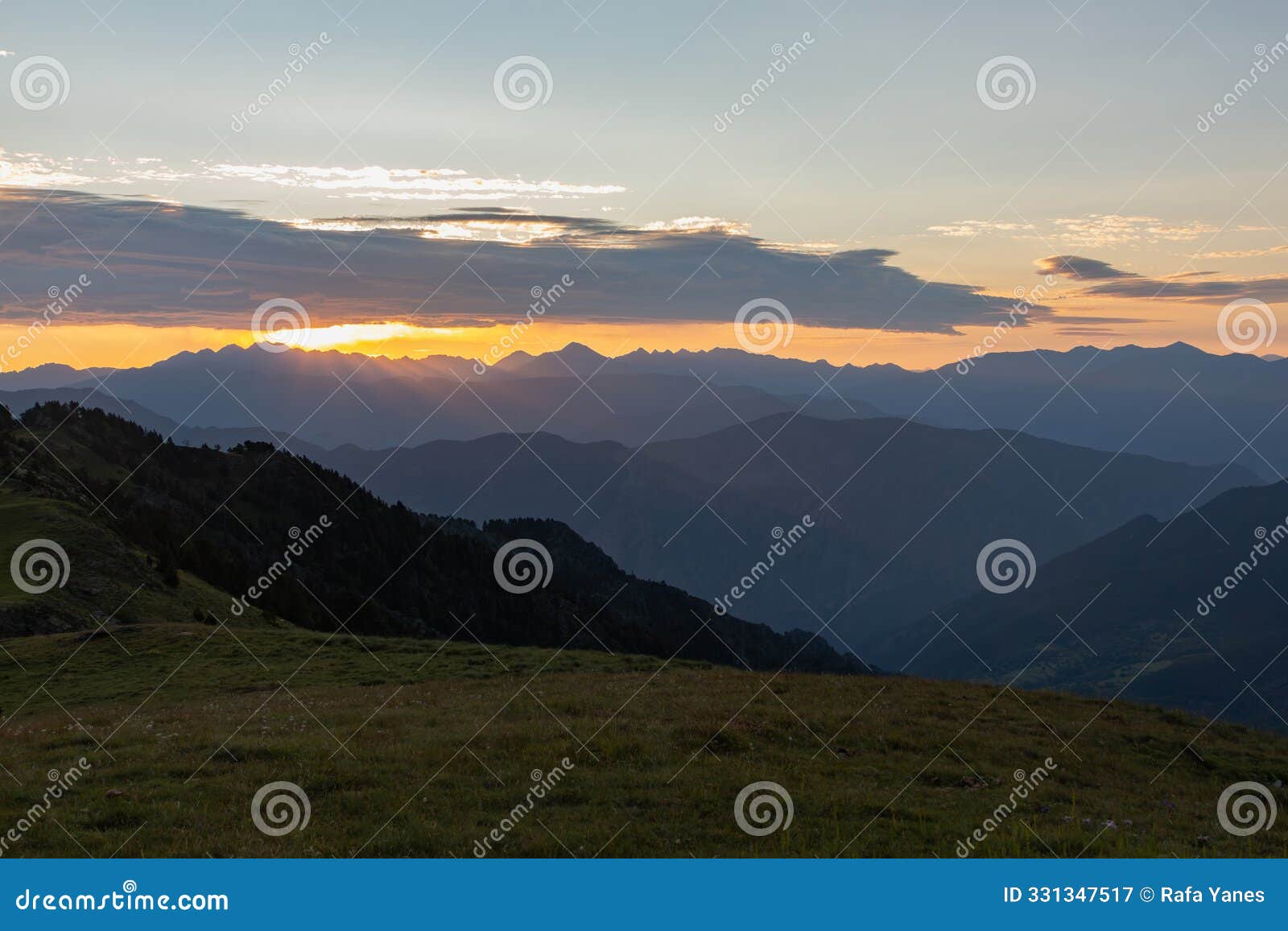 Sunrise with Sun Rays between the Clouds and Mountain Ranges Around ...