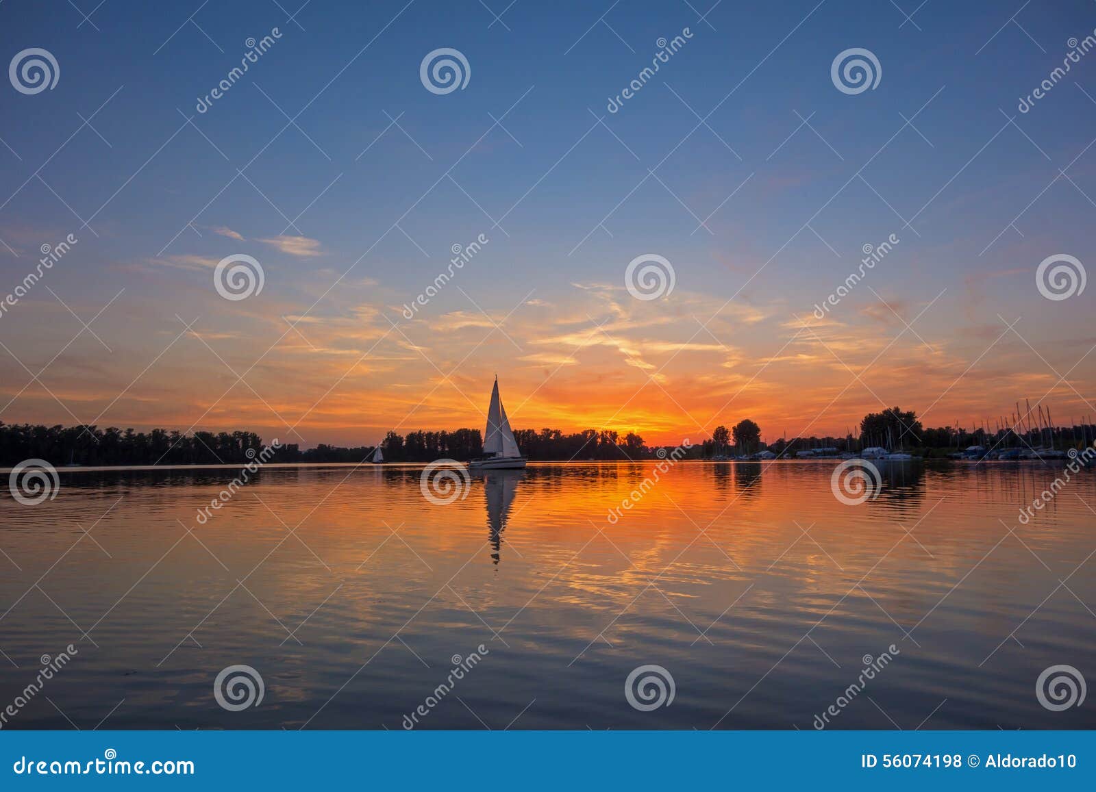 Sunrise / sunset at a lake stock photo. Image of cloudscape - 56074198