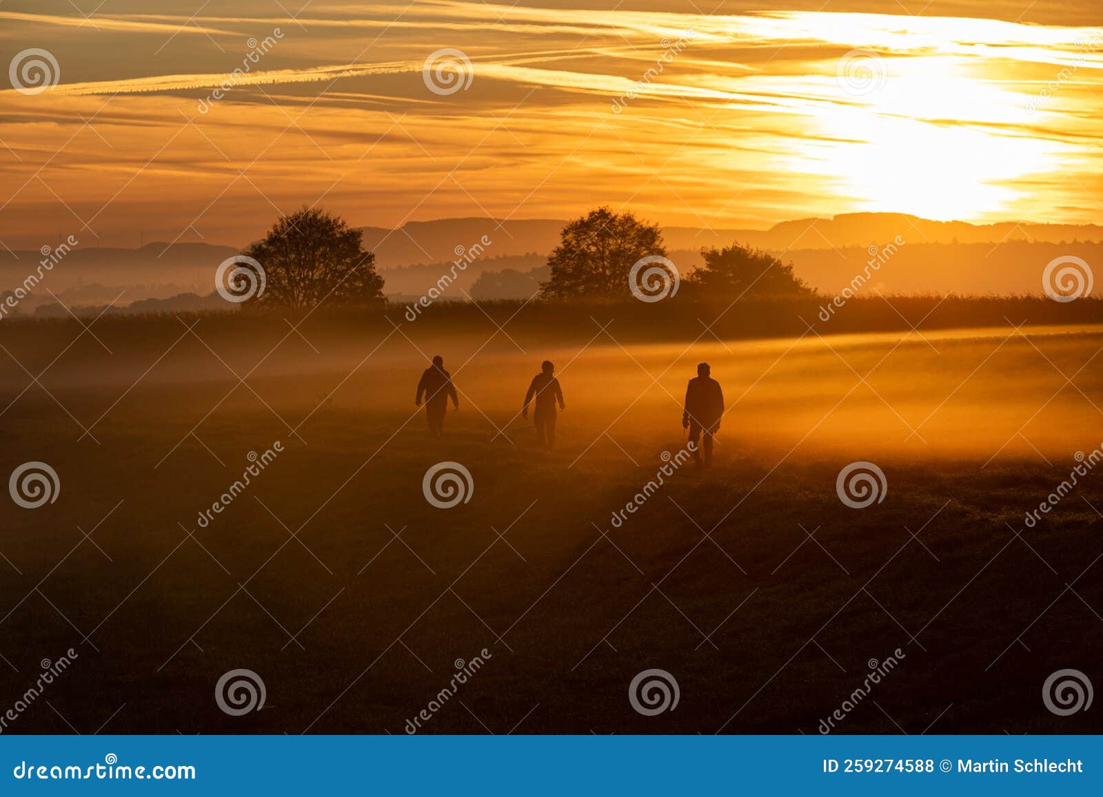 Sunrise with Three People in the Mist Stock Photo - Image of ...